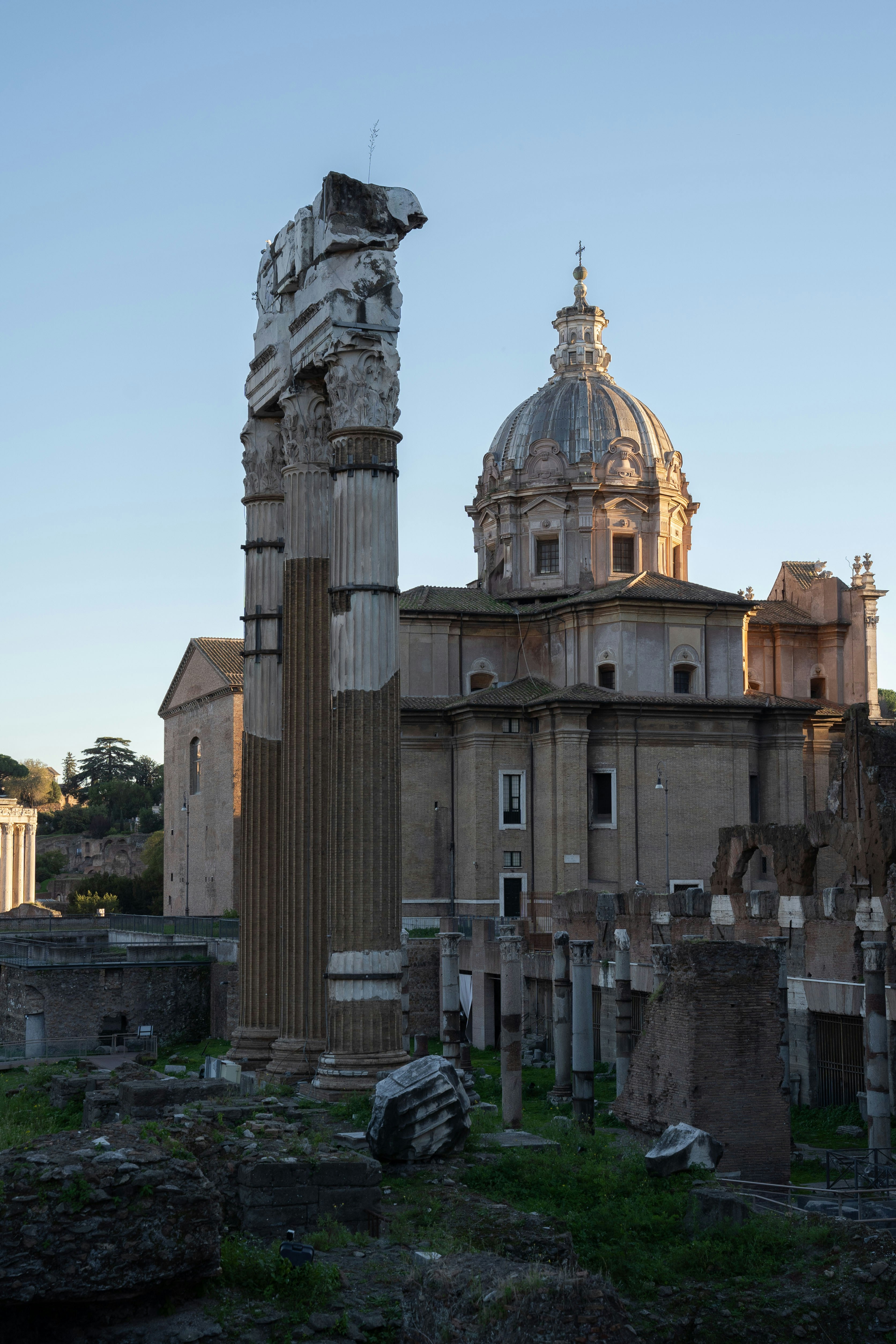 A large building with a tall tower next to a cemetery photo – Free Rome ...