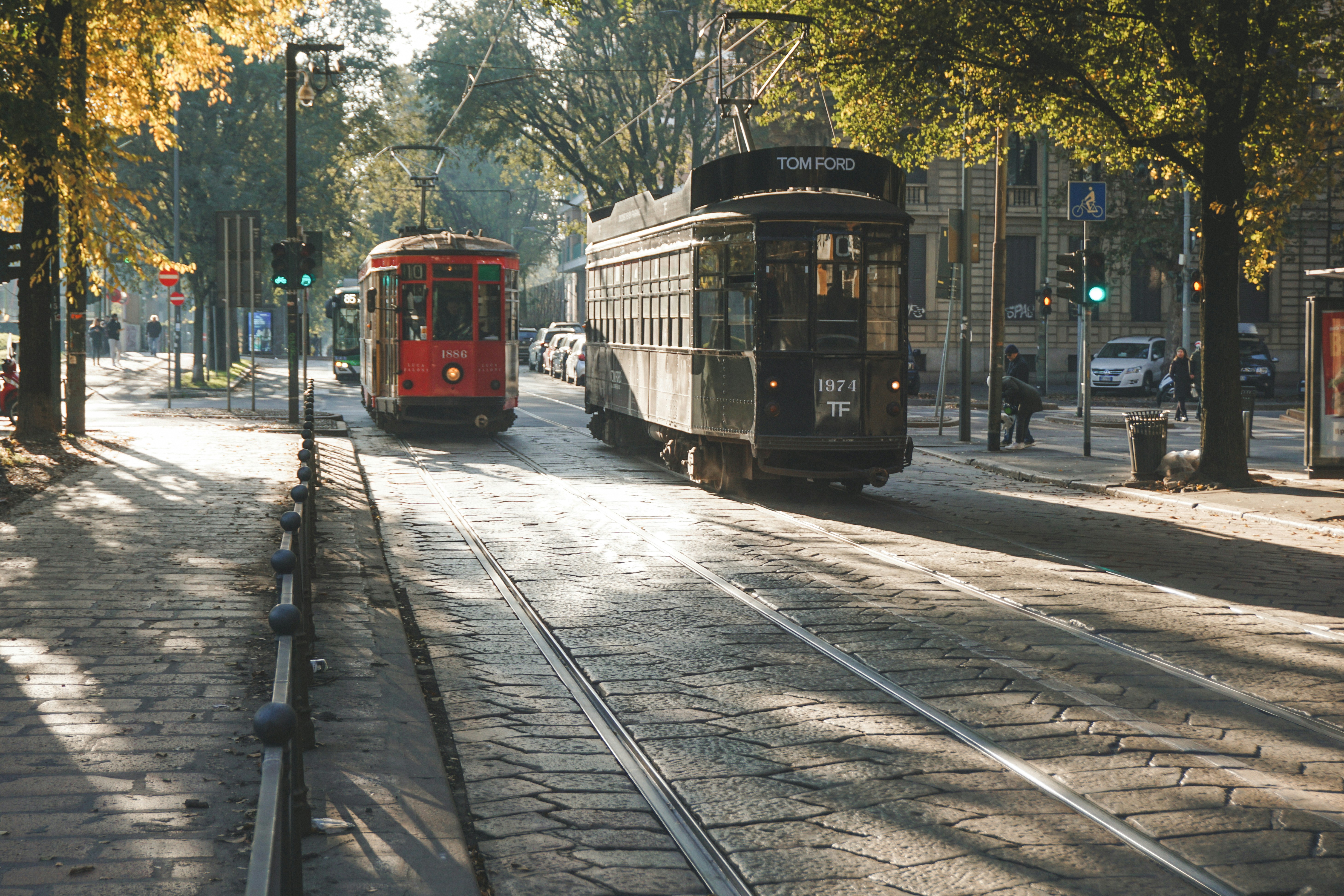 A couple of trolleys that are sitting on the tracks photo – Free Milan ...