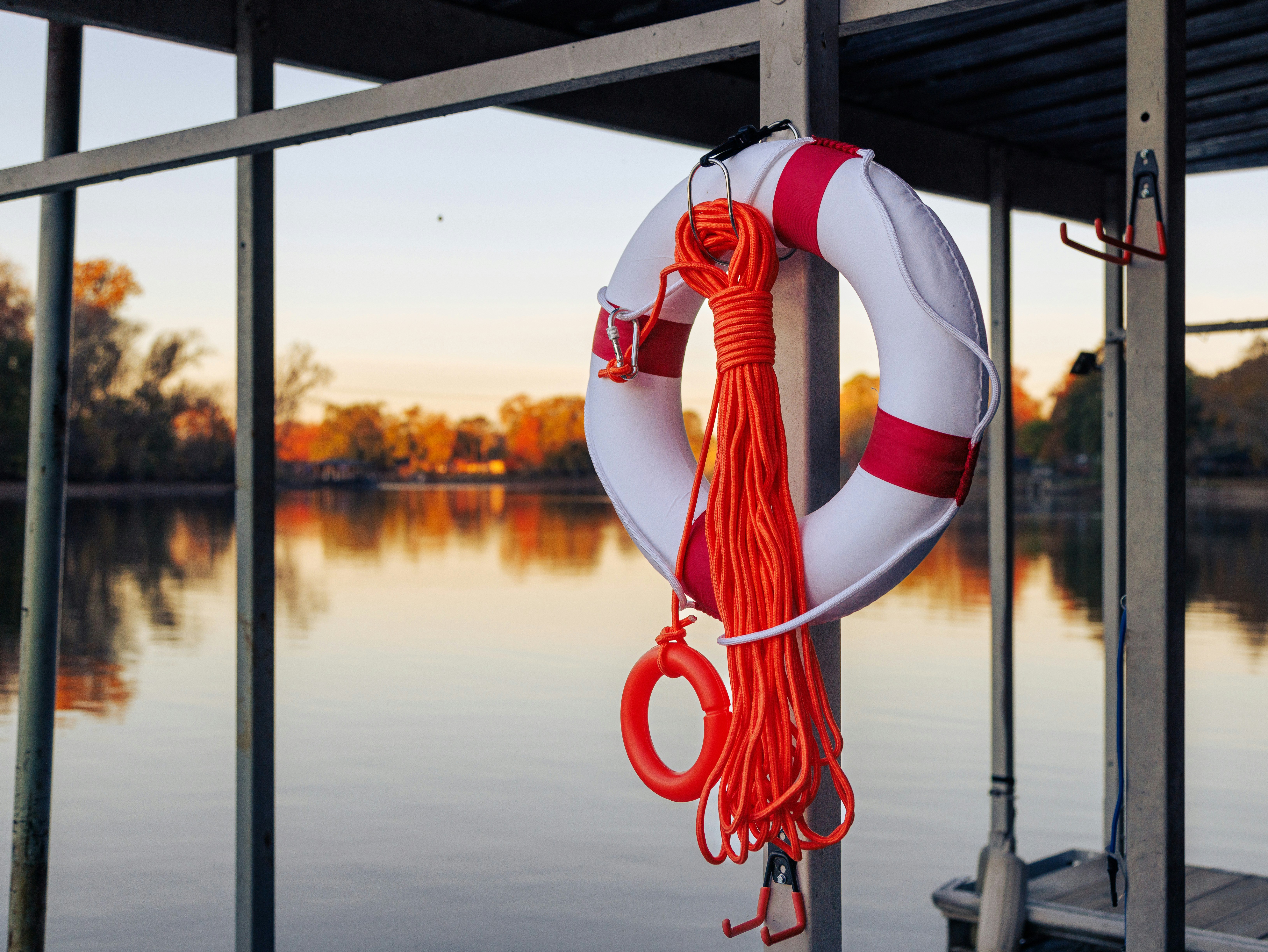 A life preserver hanging from a dock next to a body of water photo ...
