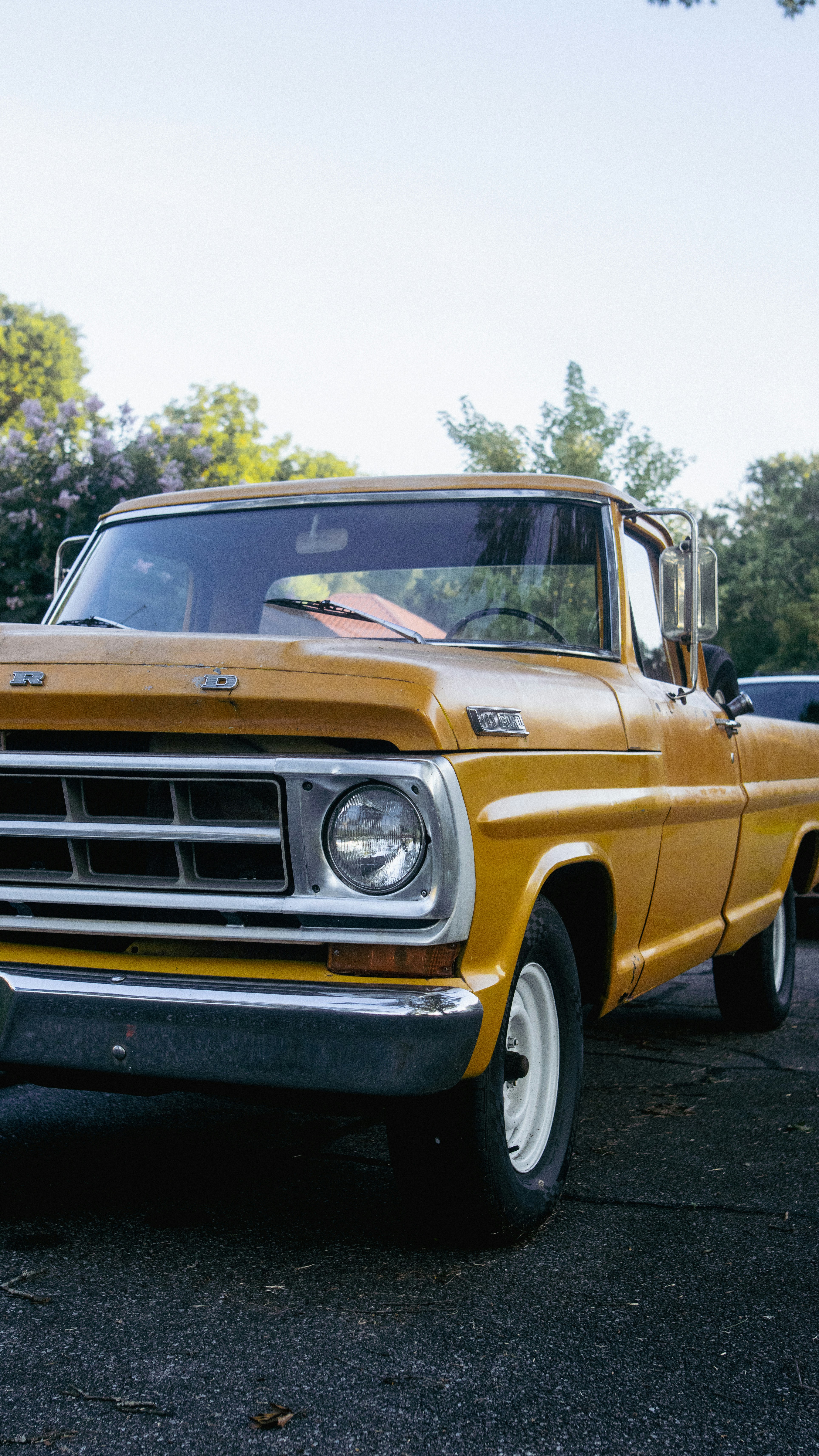 A yellow pickup truck parked in a parking lot photo – Free Ford Image ...