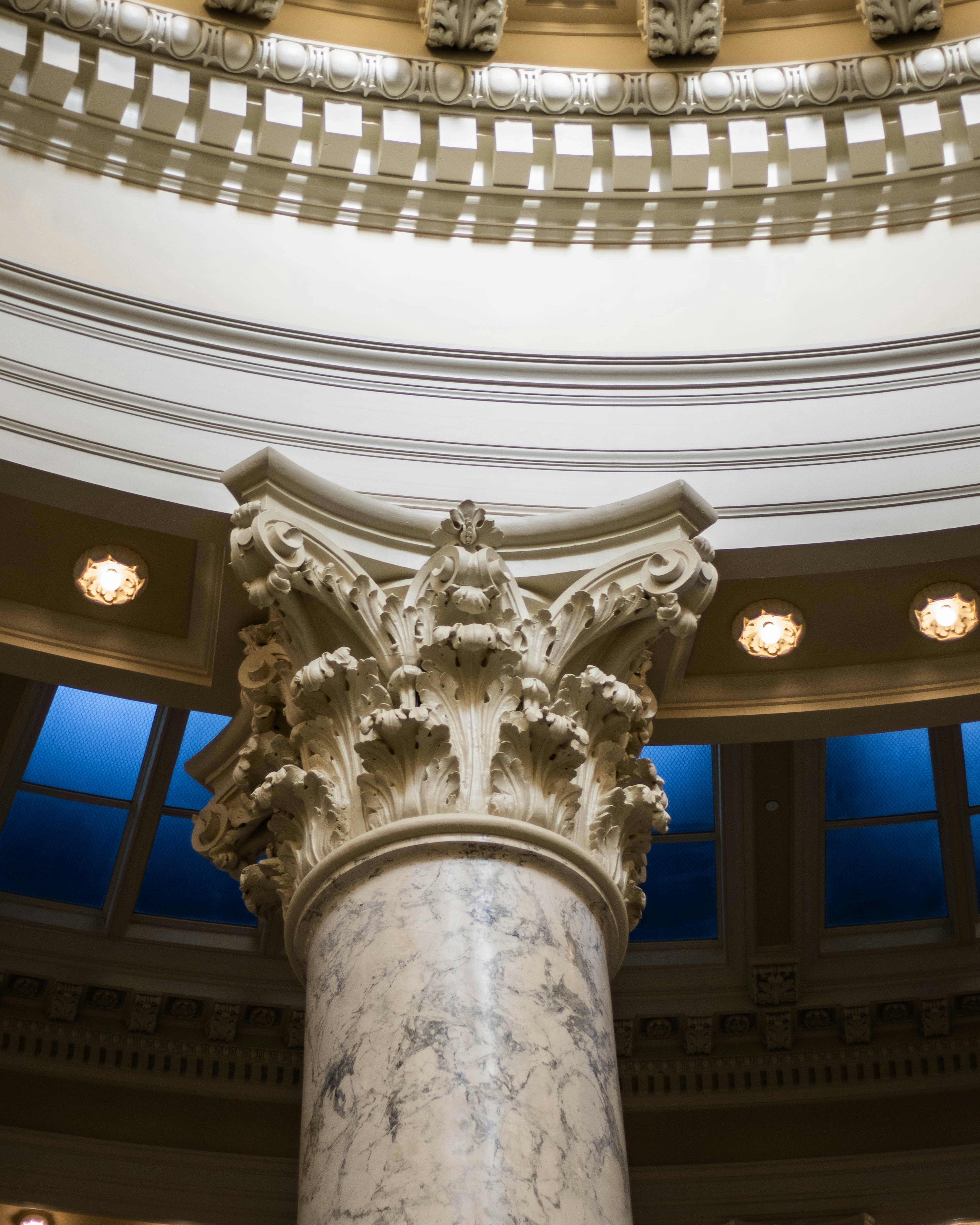 A column in a building with a skylight in the background