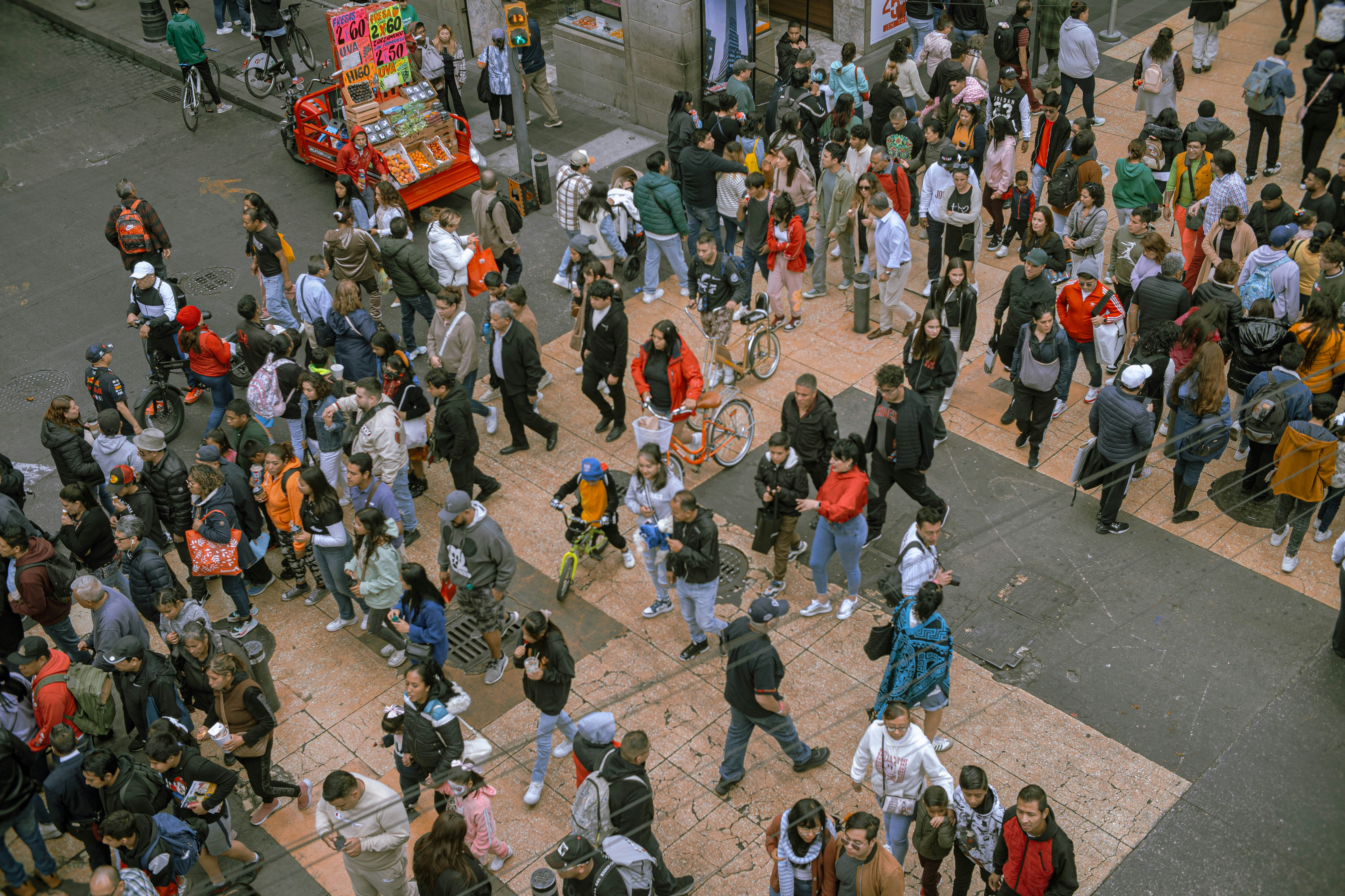 A crowd of people walking across a street photo – Free Human Image on ...