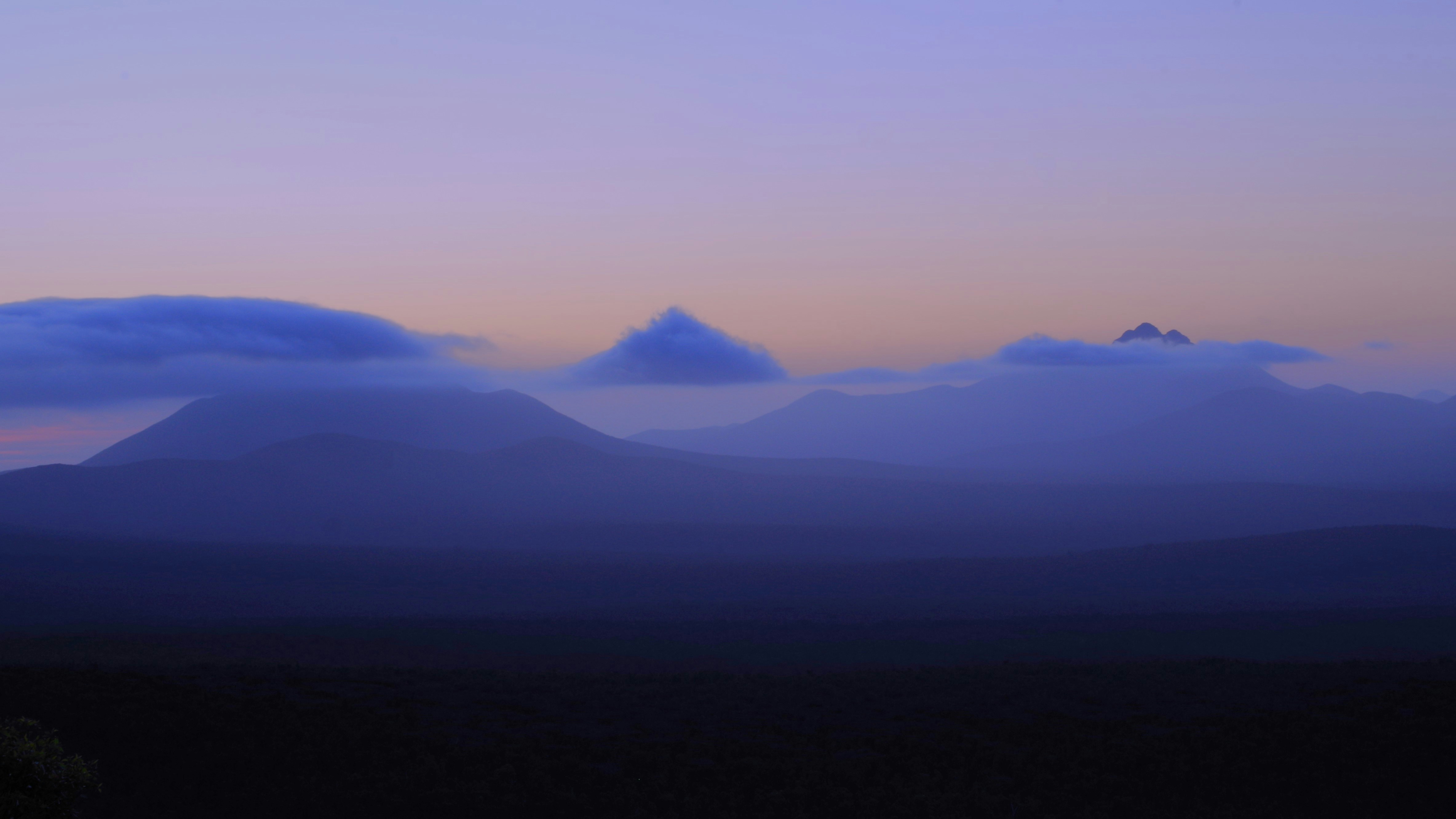 Indigo Horizon Over Layered Peaks at Blue Hour