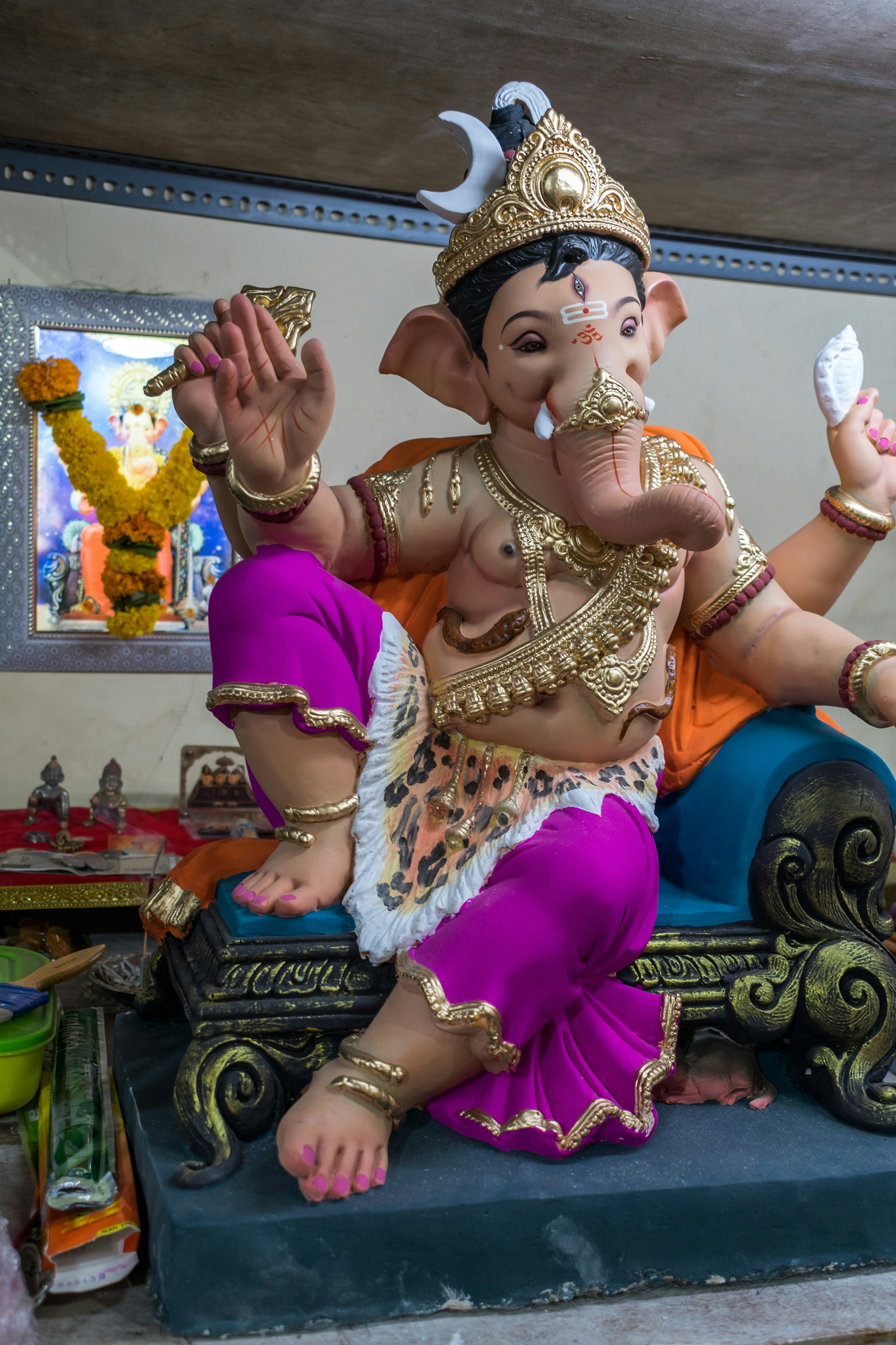 A statue of an indian god sitting on a bench photo – Free Ganesh Image ...
