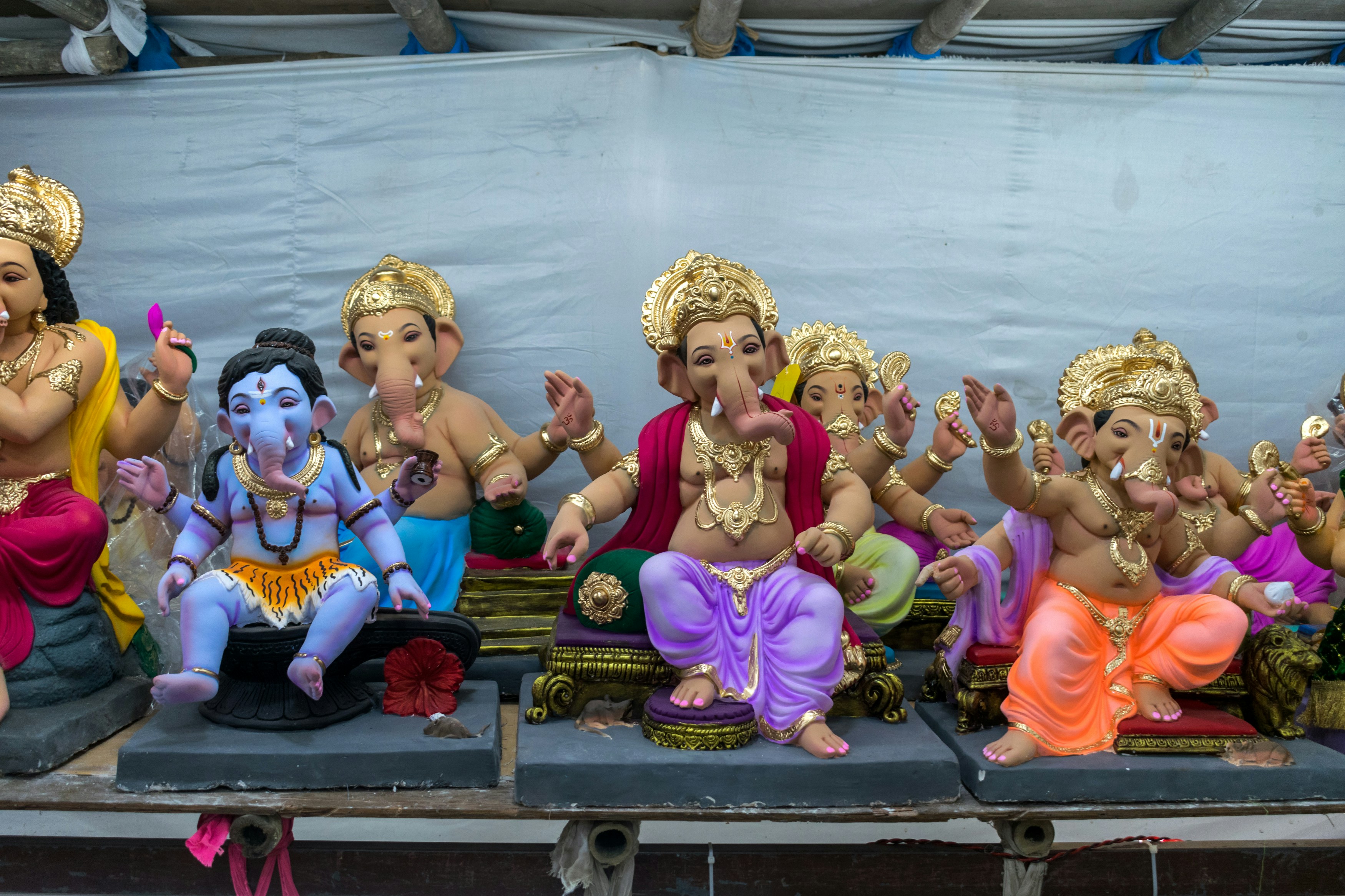 A group of statues of people sitting on a stage photo – Free Ganesh ...