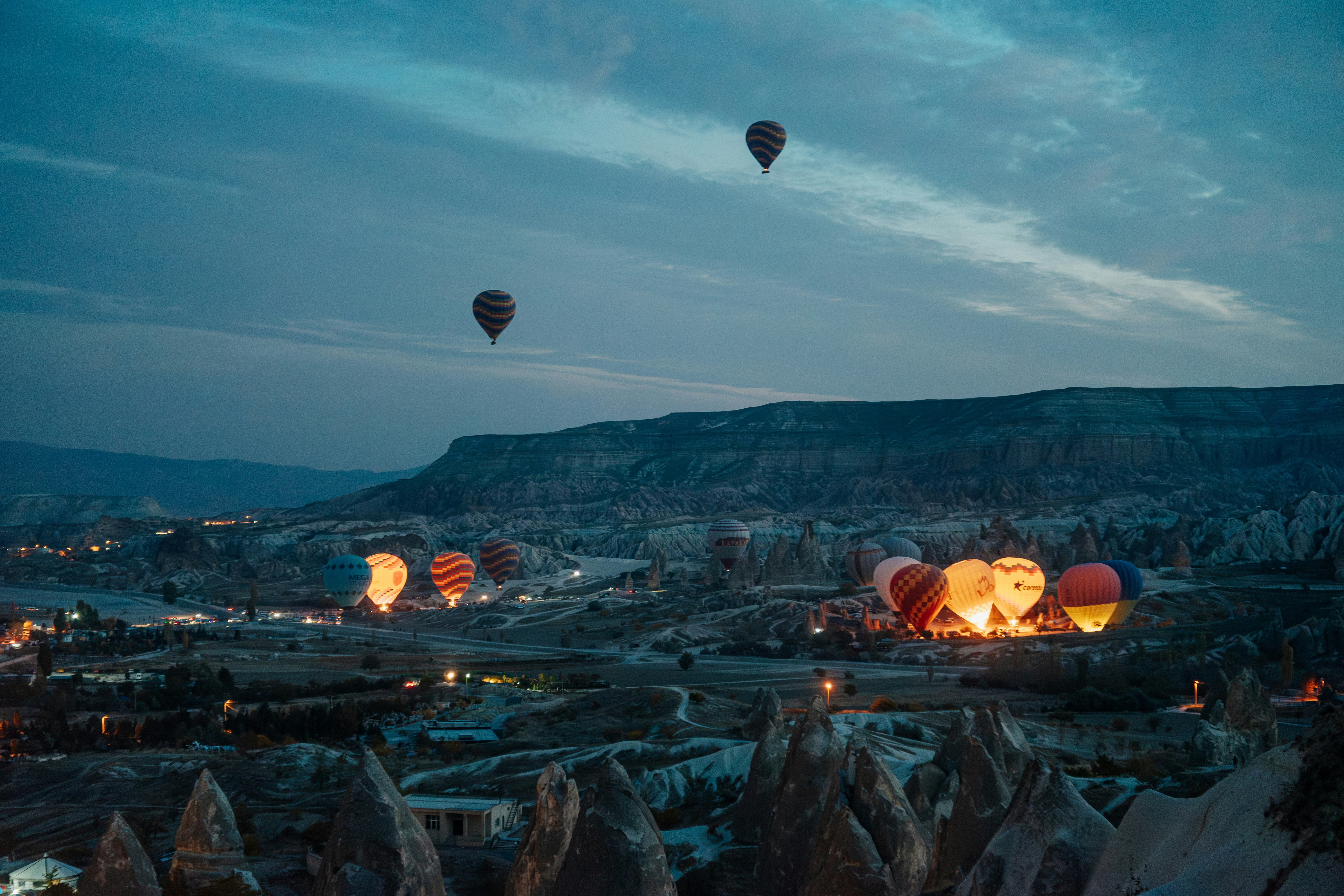 A group of hot air balloons flying over a valley photo – Free Travel ...