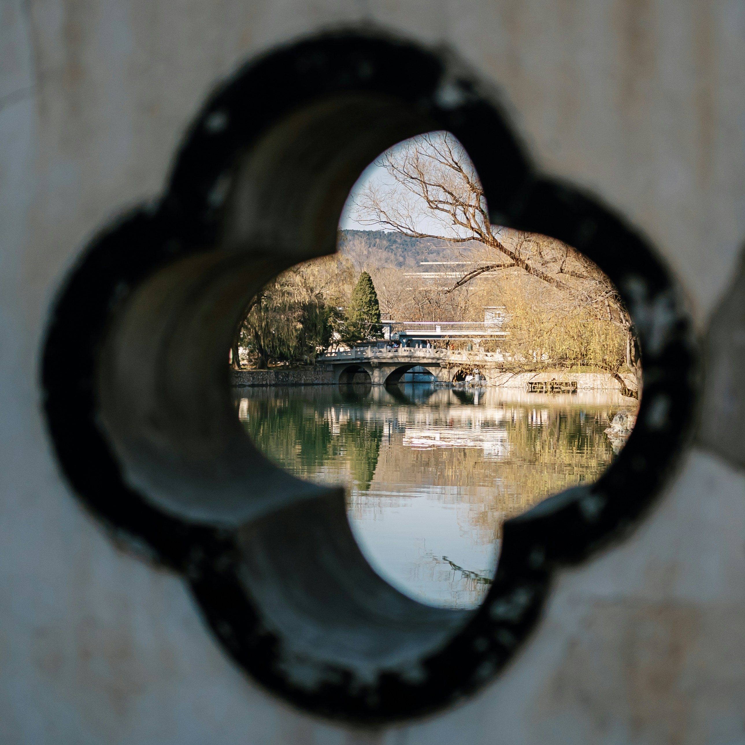 A view of a lake through a hole in a wall photo – Free Beijing Image on ...