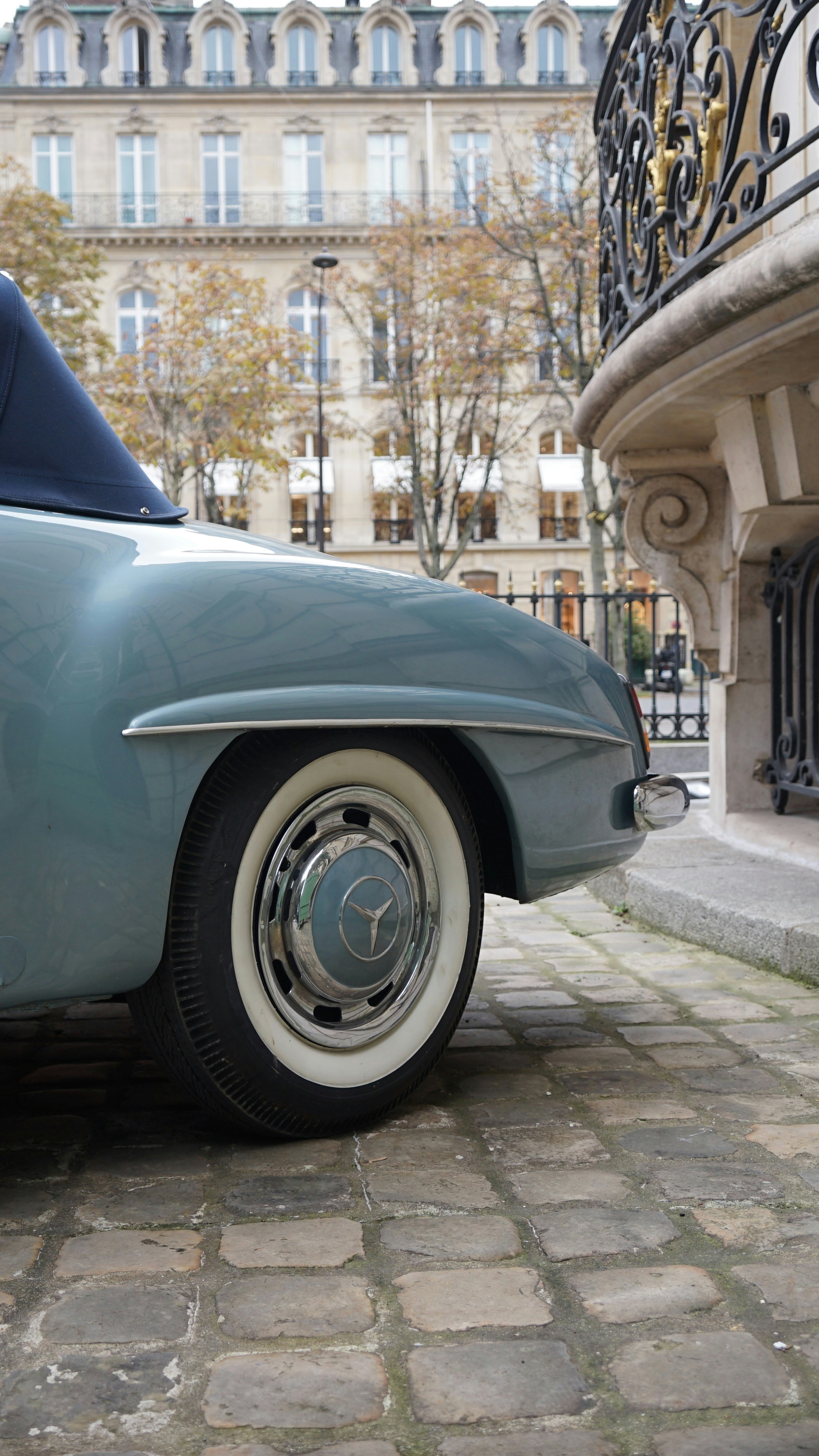 Pastel Mercedes on Cobblestones: Chrome Star under Parisian Architecture