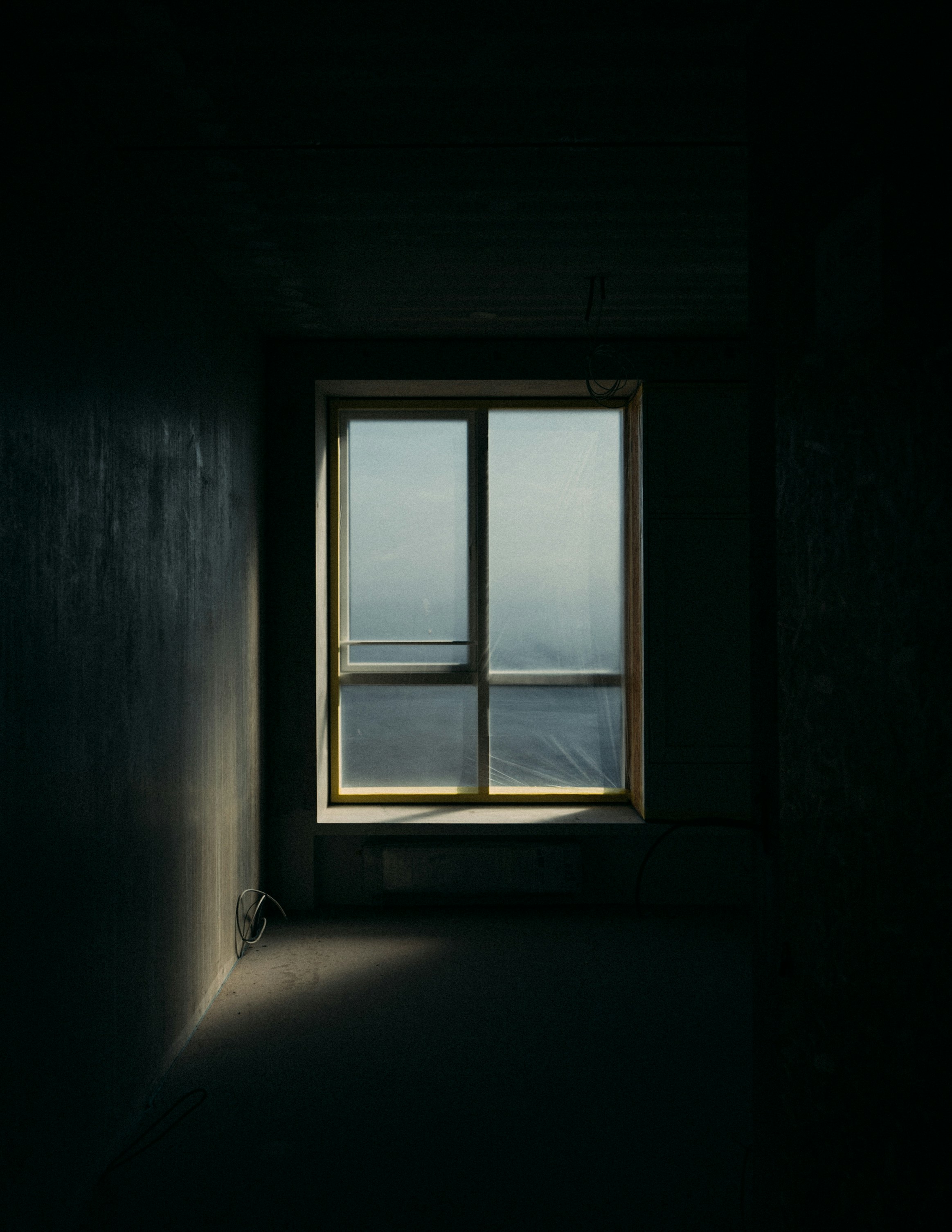 A dark room with a light coming through a window photo – Free Window ...