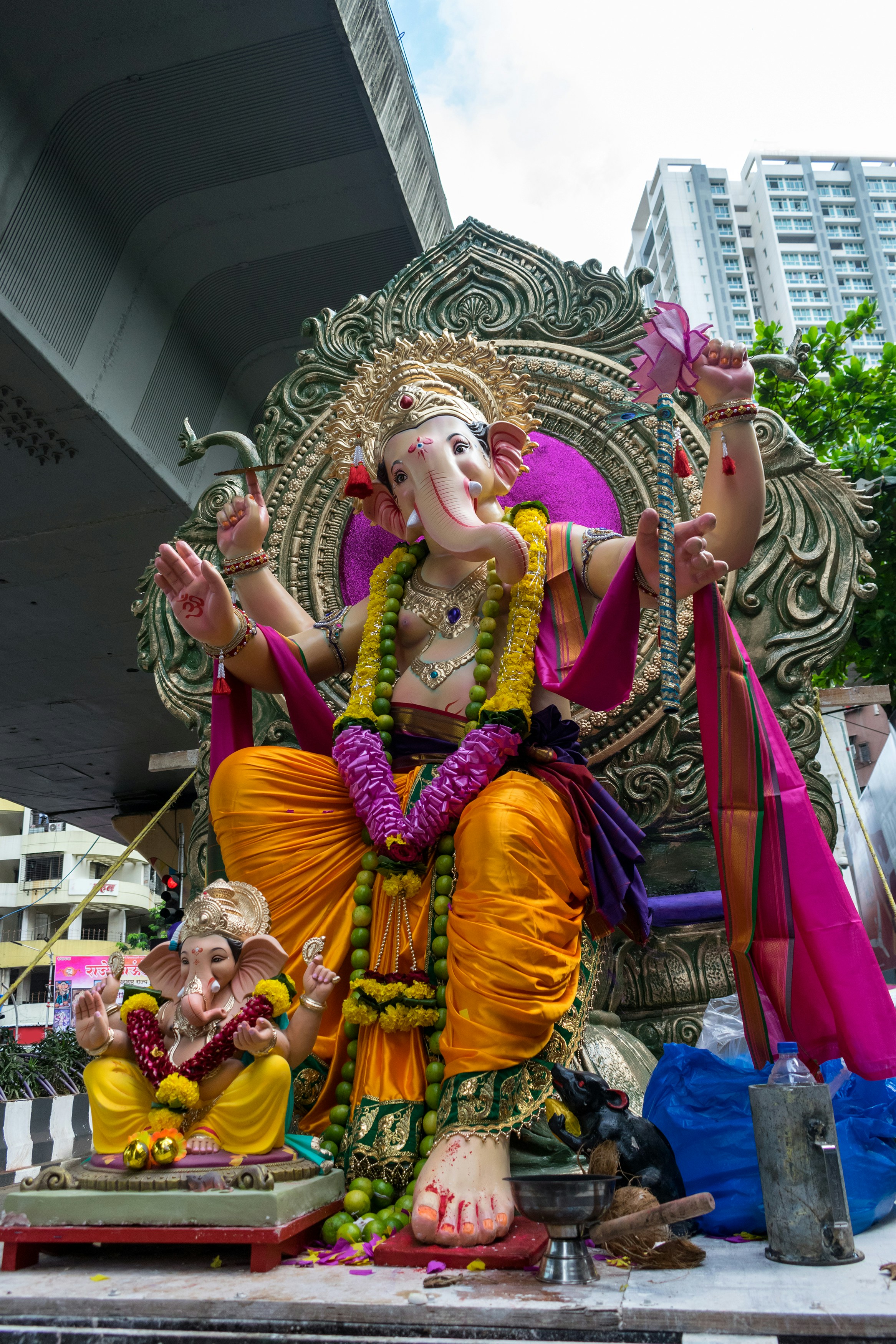 A statue of a hindu god sitting on a bench photo – Free Ganesh Image on ...