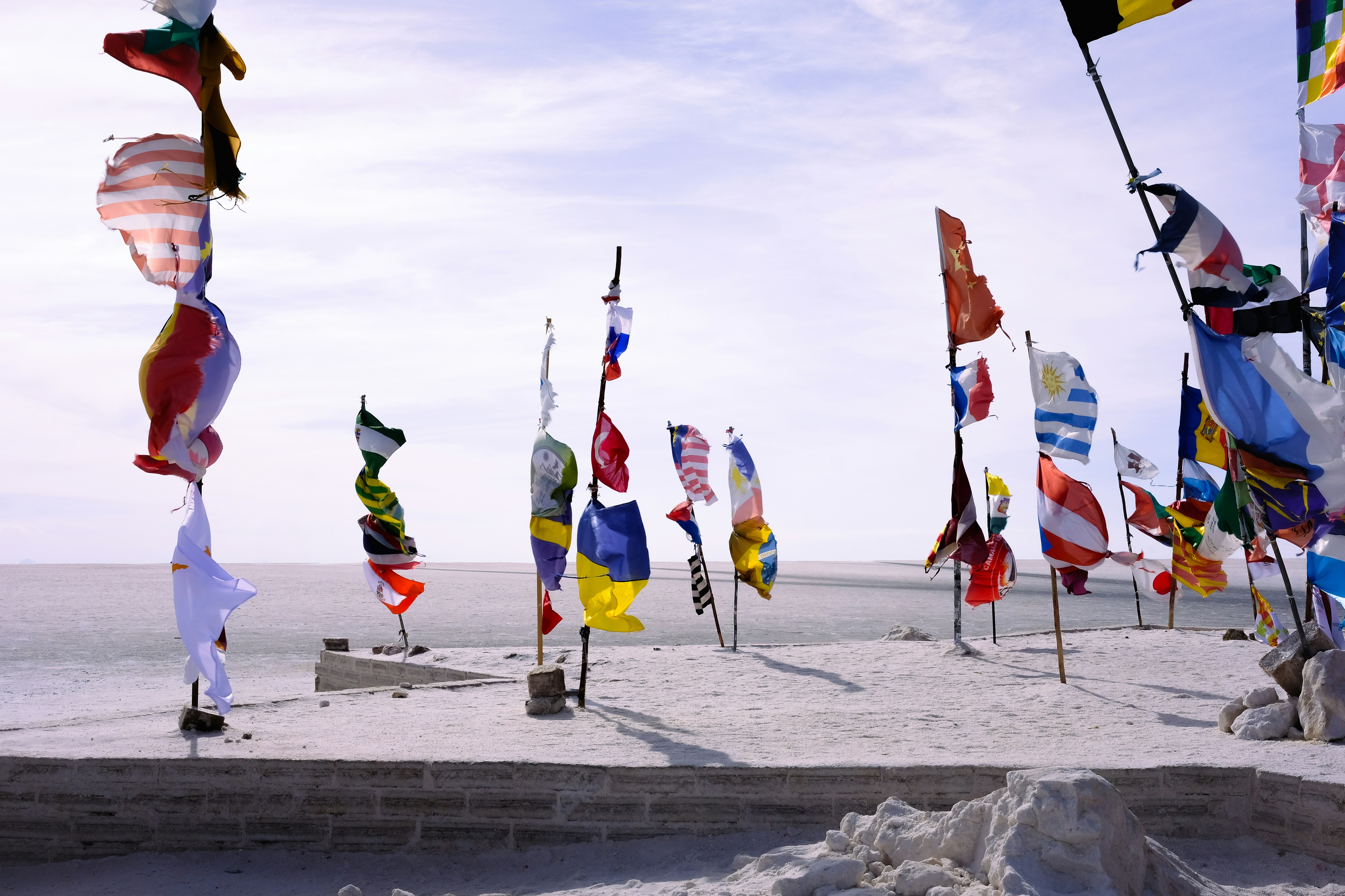 A bunch of flags that are in the sand photo – Free Beach Image on Unsplash