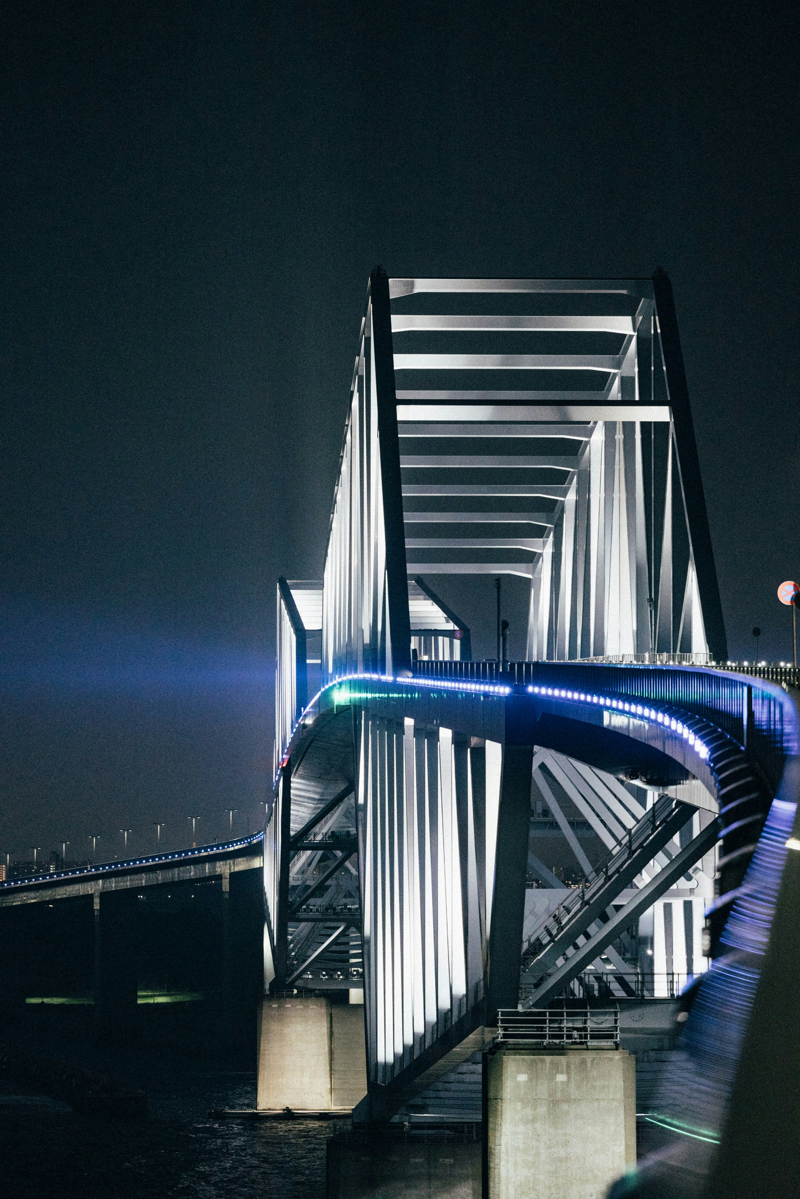 A very tall bridge with a very long blue line going across it photo ...