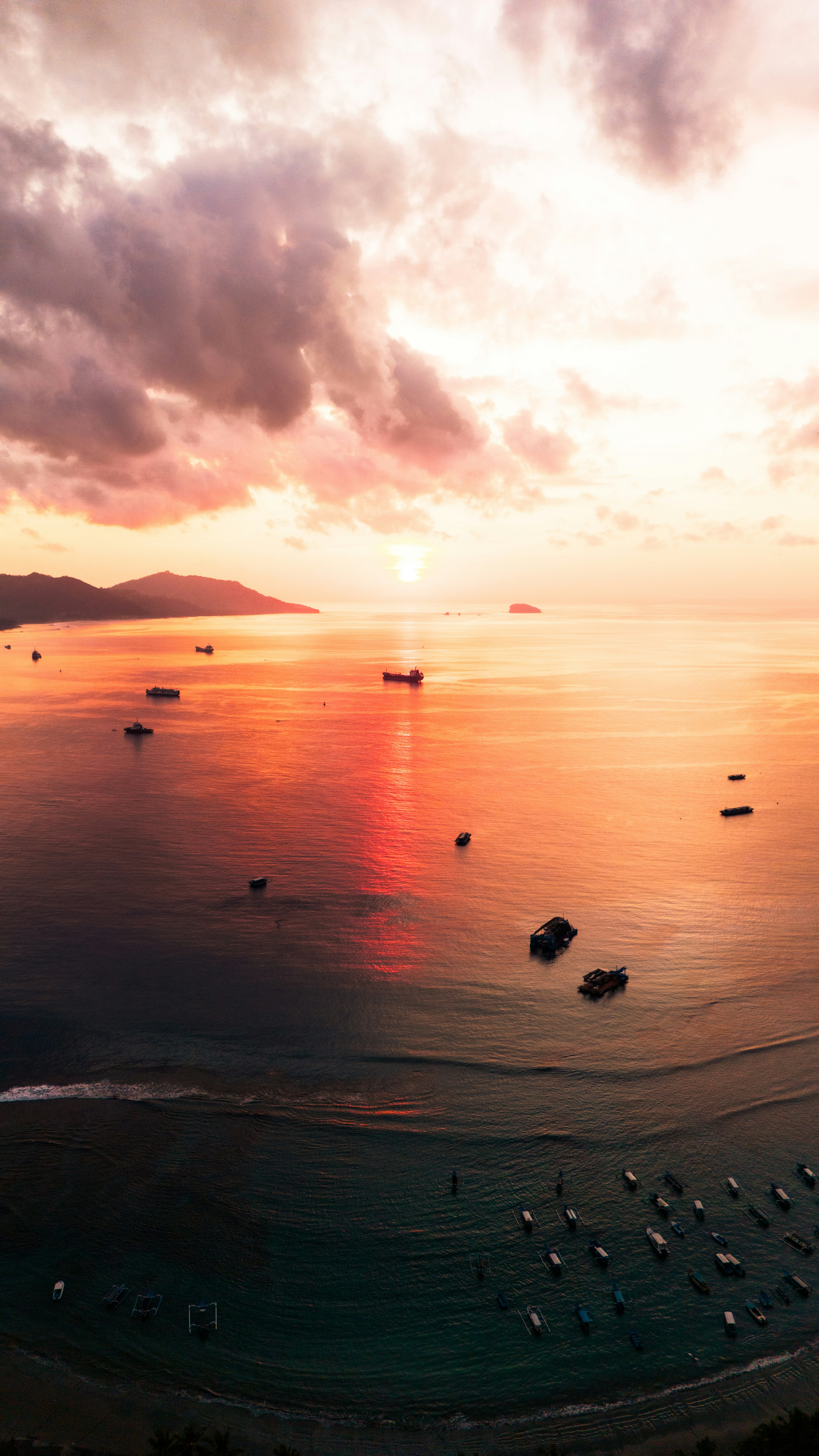 Horizon Choir: Boats Dot a Golden Sea at Sunset