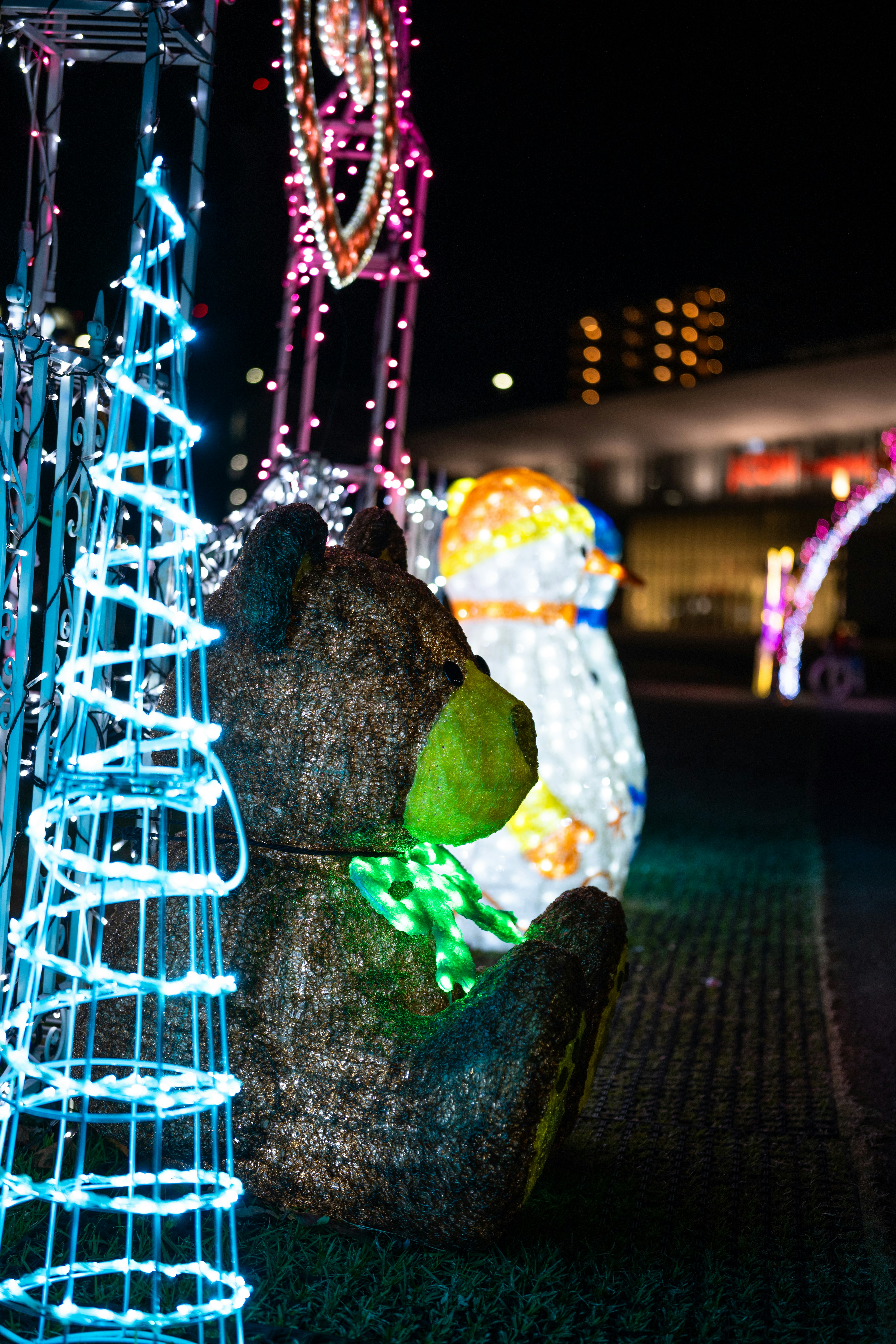 Emerald Ember: A Stone Bear Amid Neon Holiday Lights