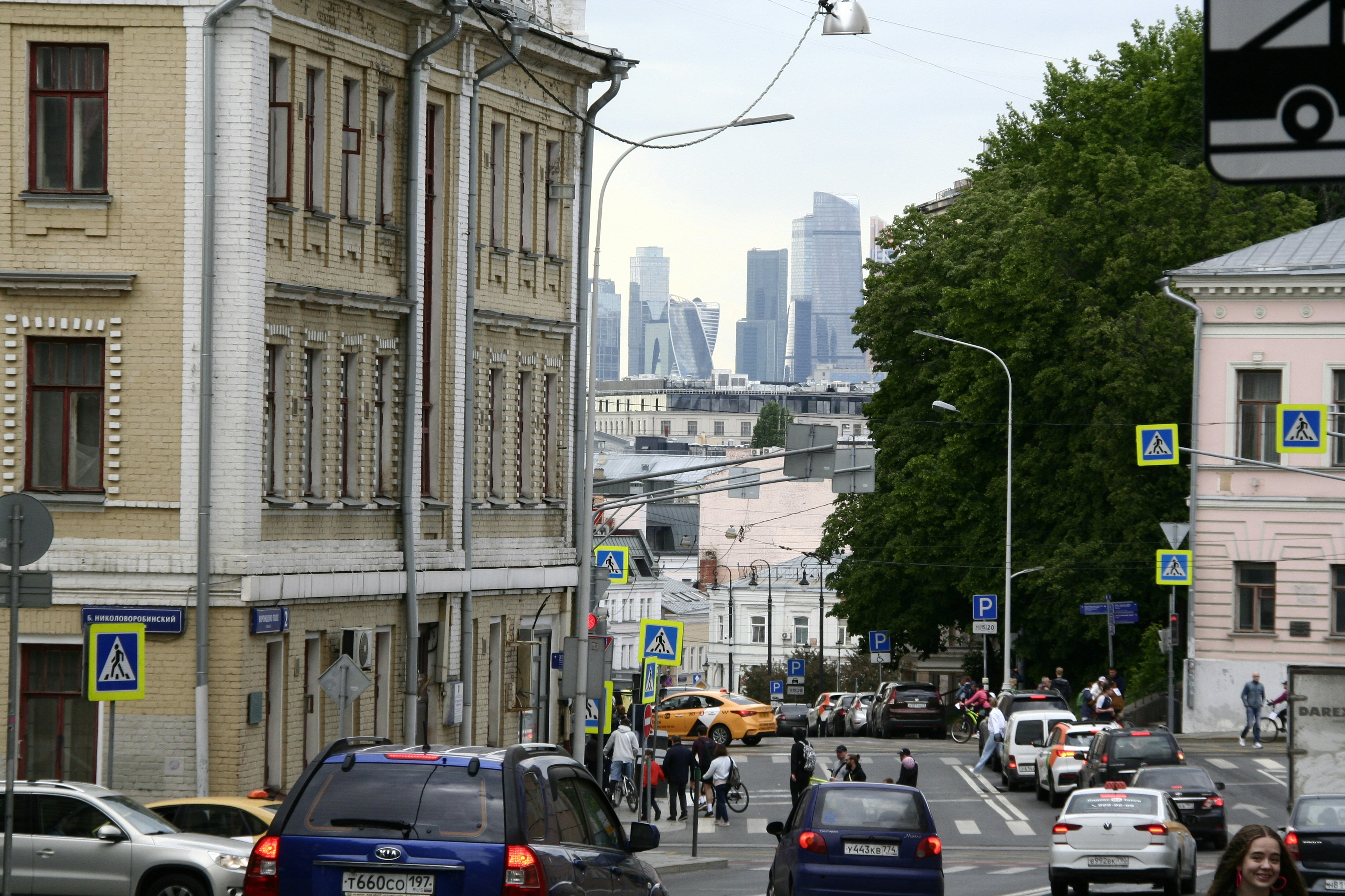 Laneways to the Glass Horizon: A Busy Street Curves Toward a Modern Skyline