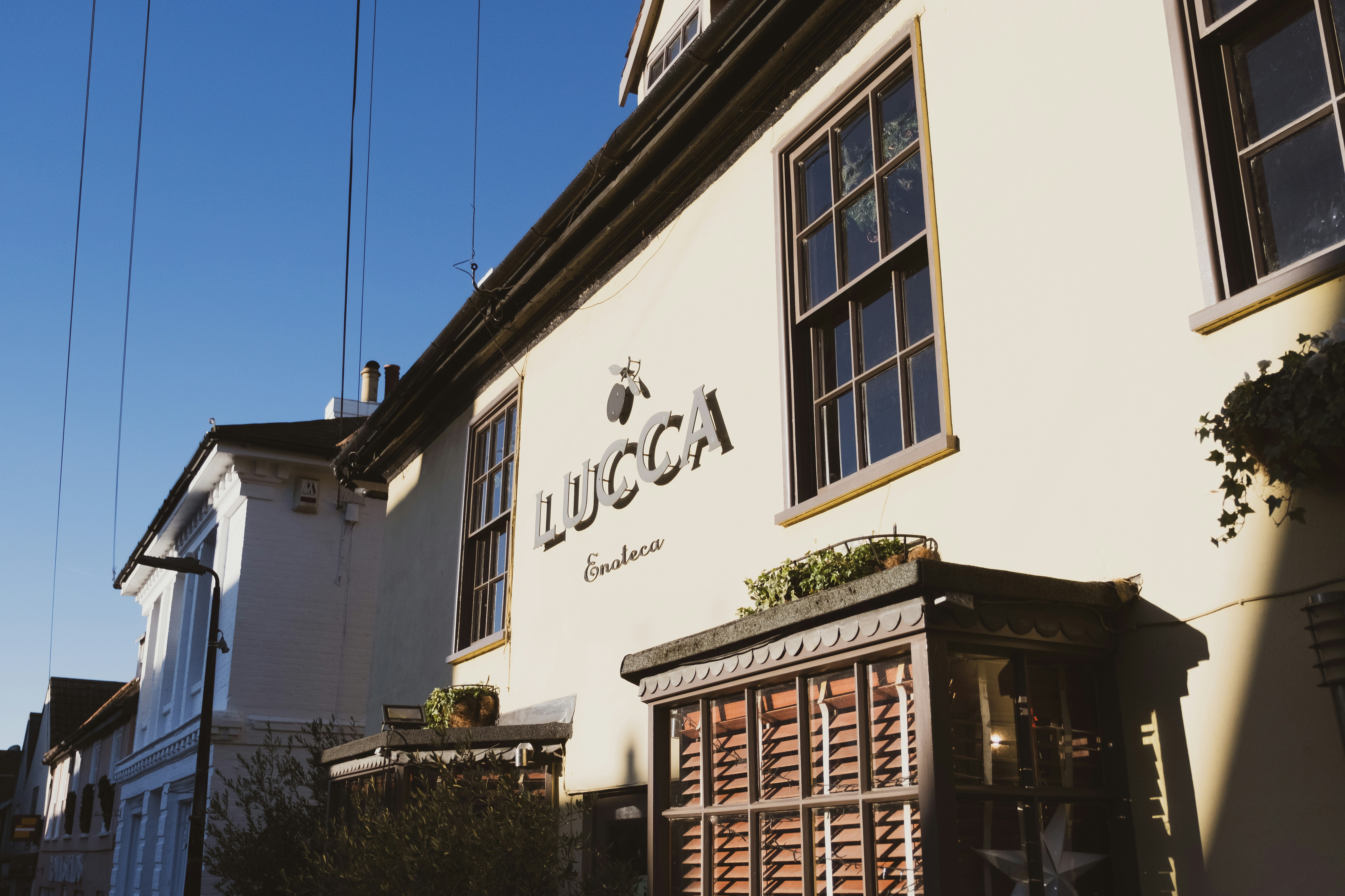 Lucica’s Sunlit Facade: Quiet Morning on a Whitewashed Street