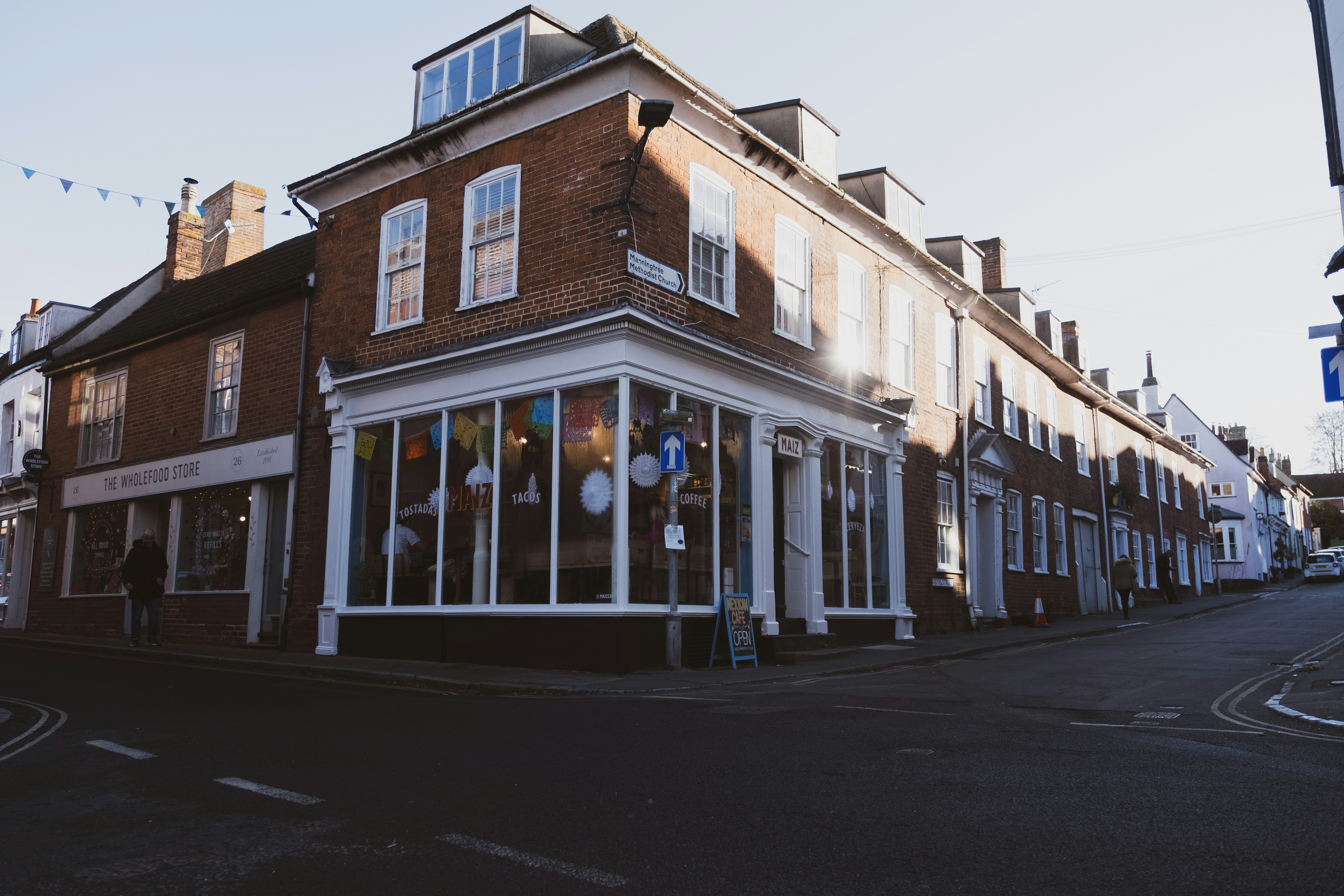 A row of buildings on a street corner photo – Free Manningtree Image on ...