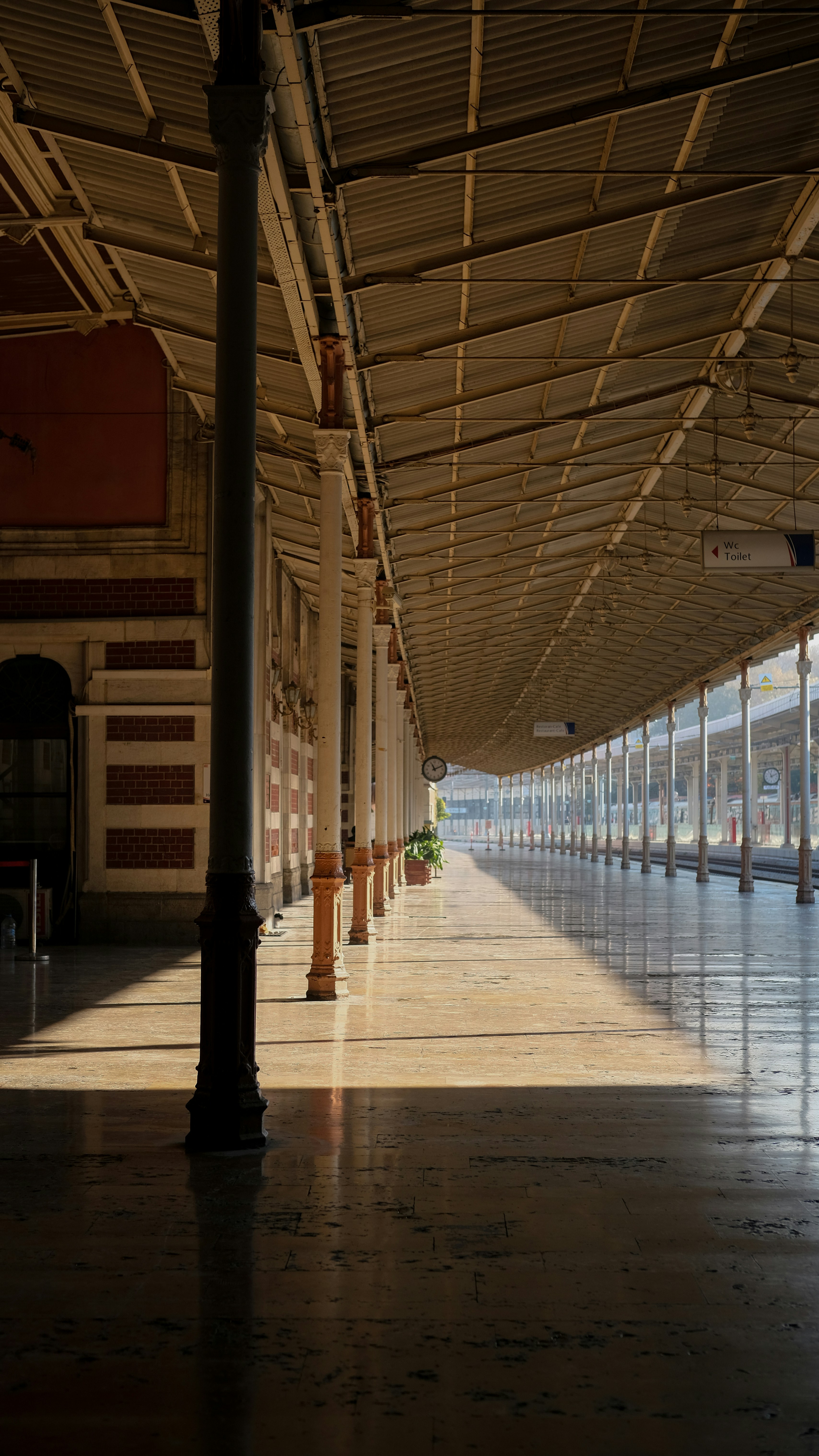 An empty train station with a train on the tracks photo – Free Building ...