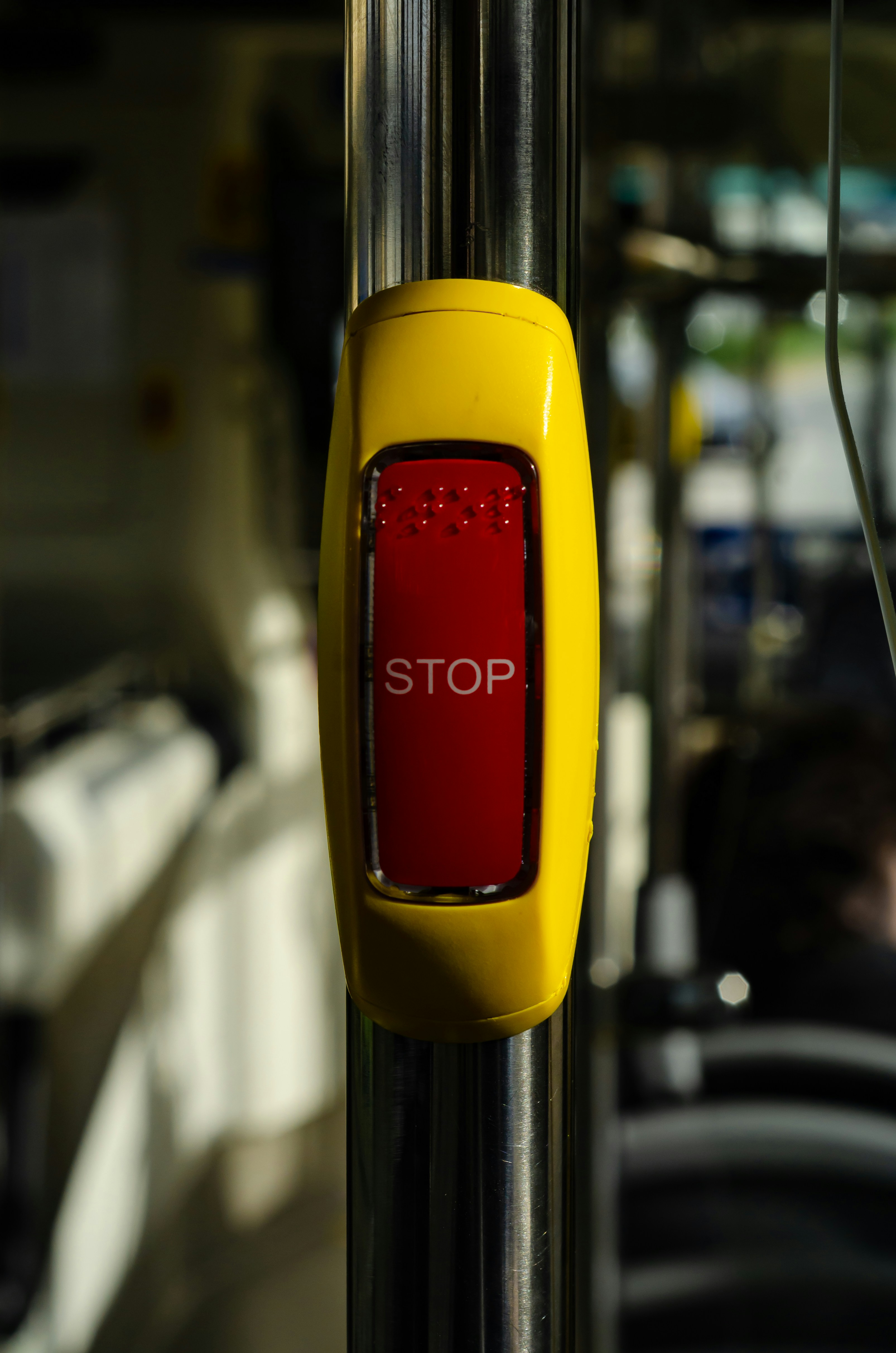 A yellow and red stop button on a metal pole photo – Free Public ...