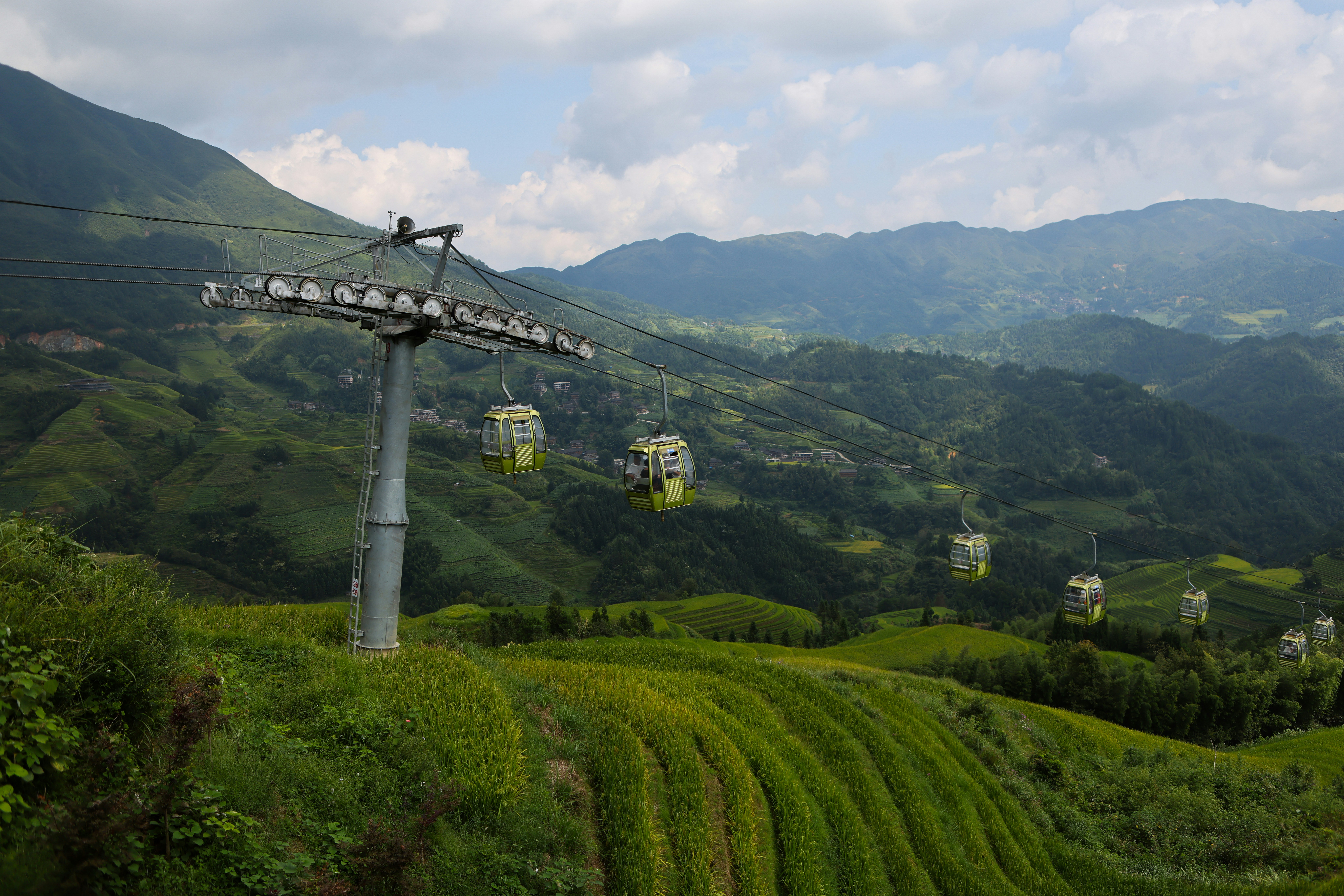 Cabled Descent: A Cable Car Spine Over Verdant Terraces