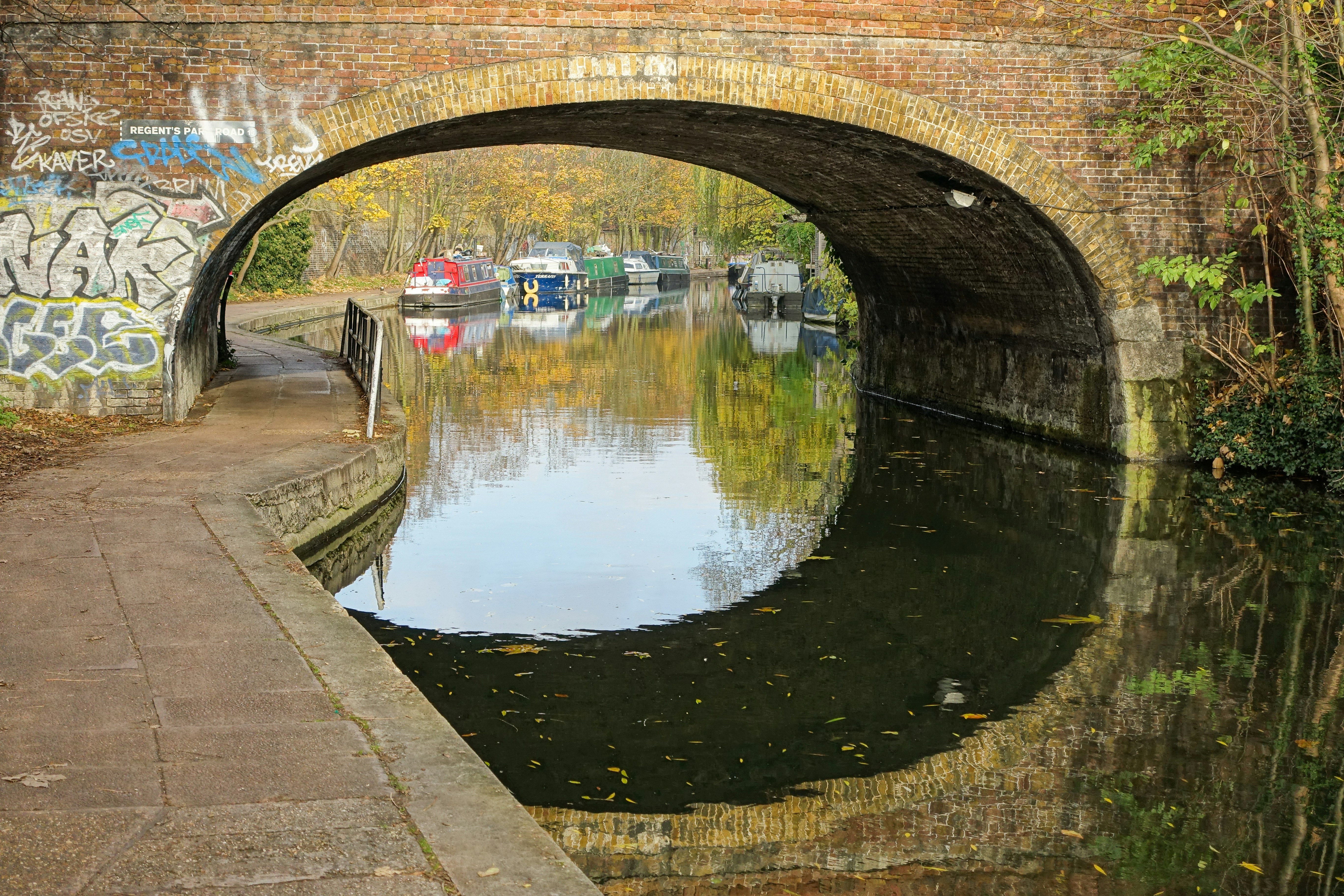 A bridge over a river with graffiti on it