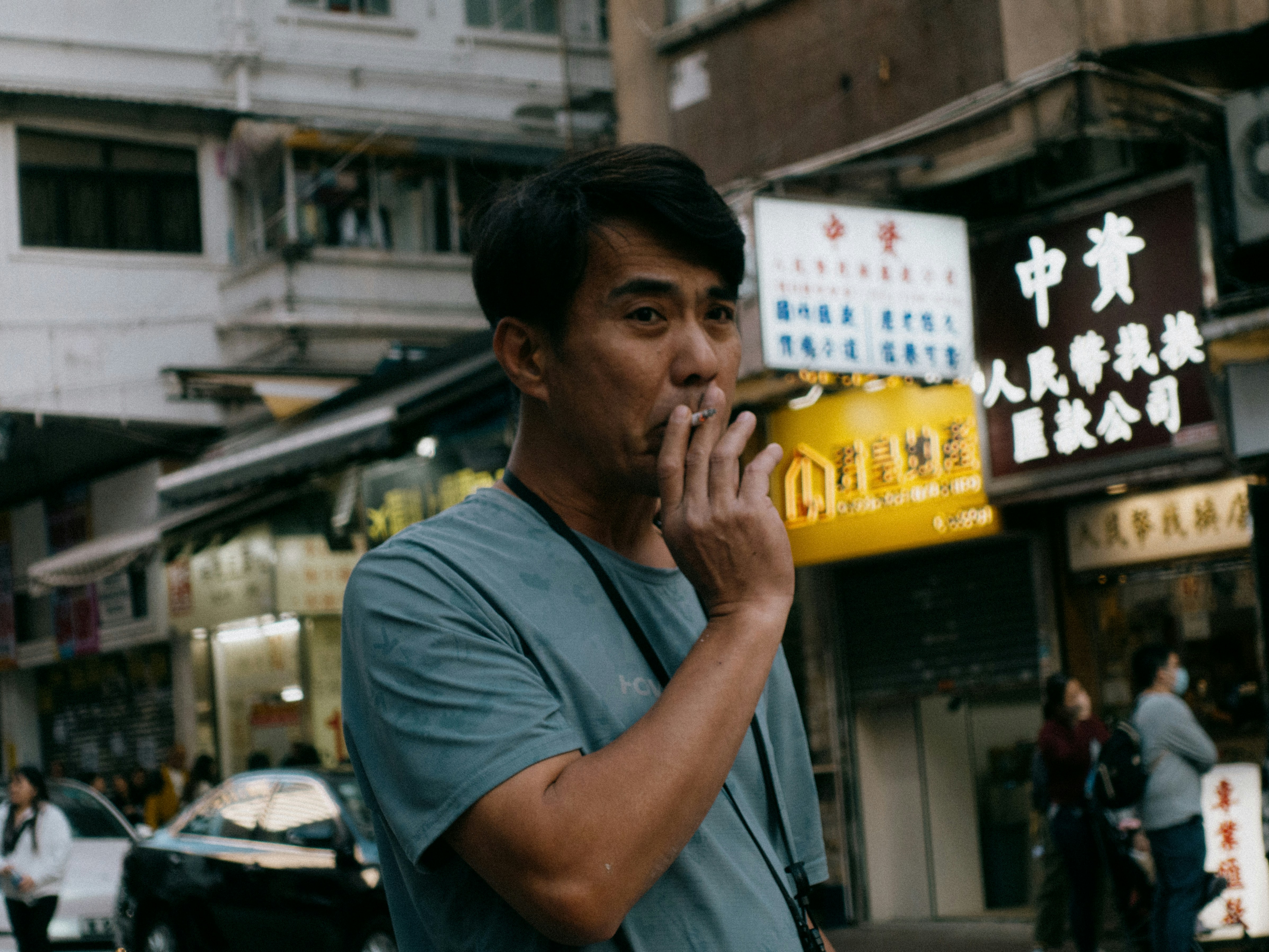 Neon-Lit Pause: a street portrait beneath crowded storefronts