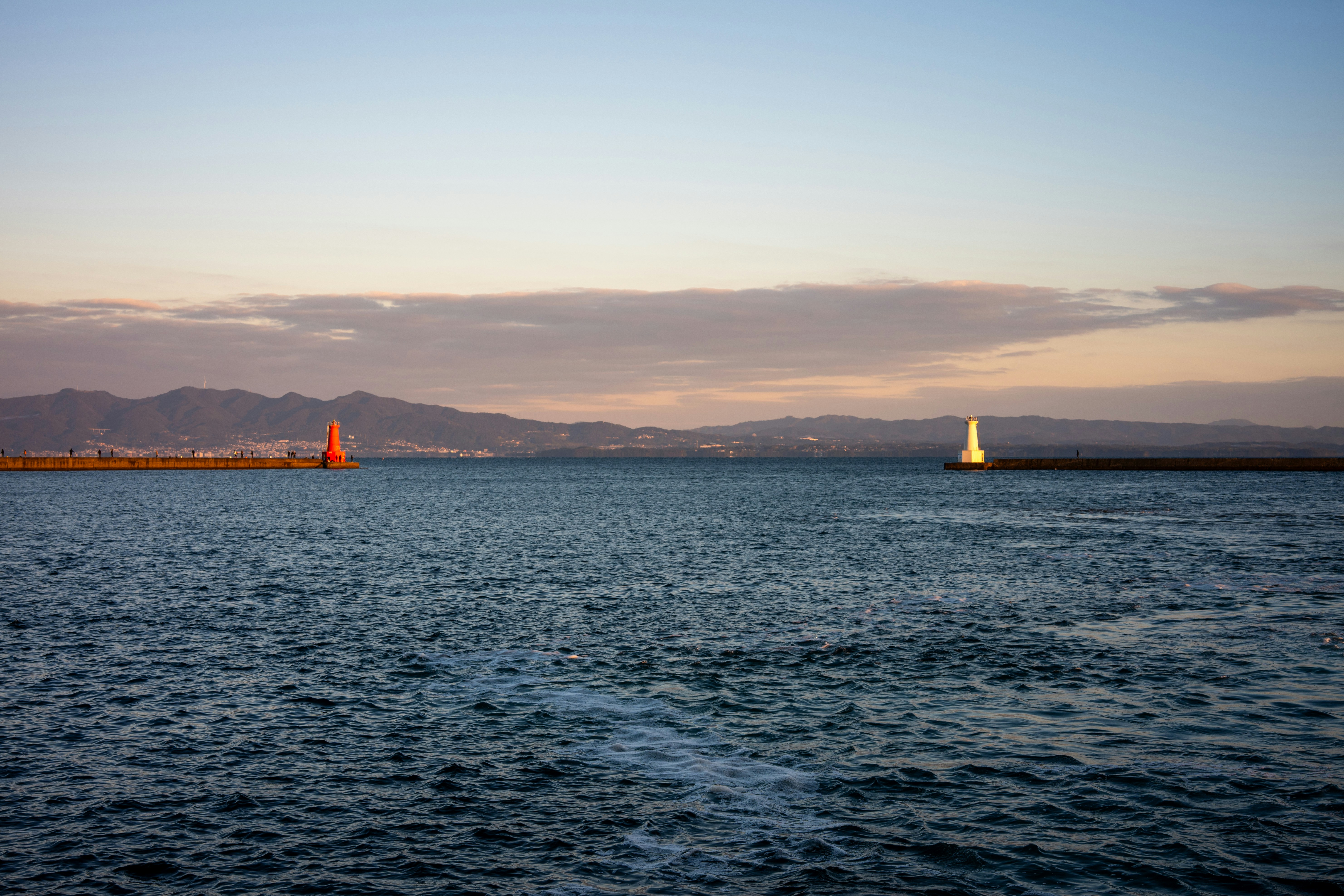 A sailboat sailing on a large body of water photo – Free Sea Image on ...