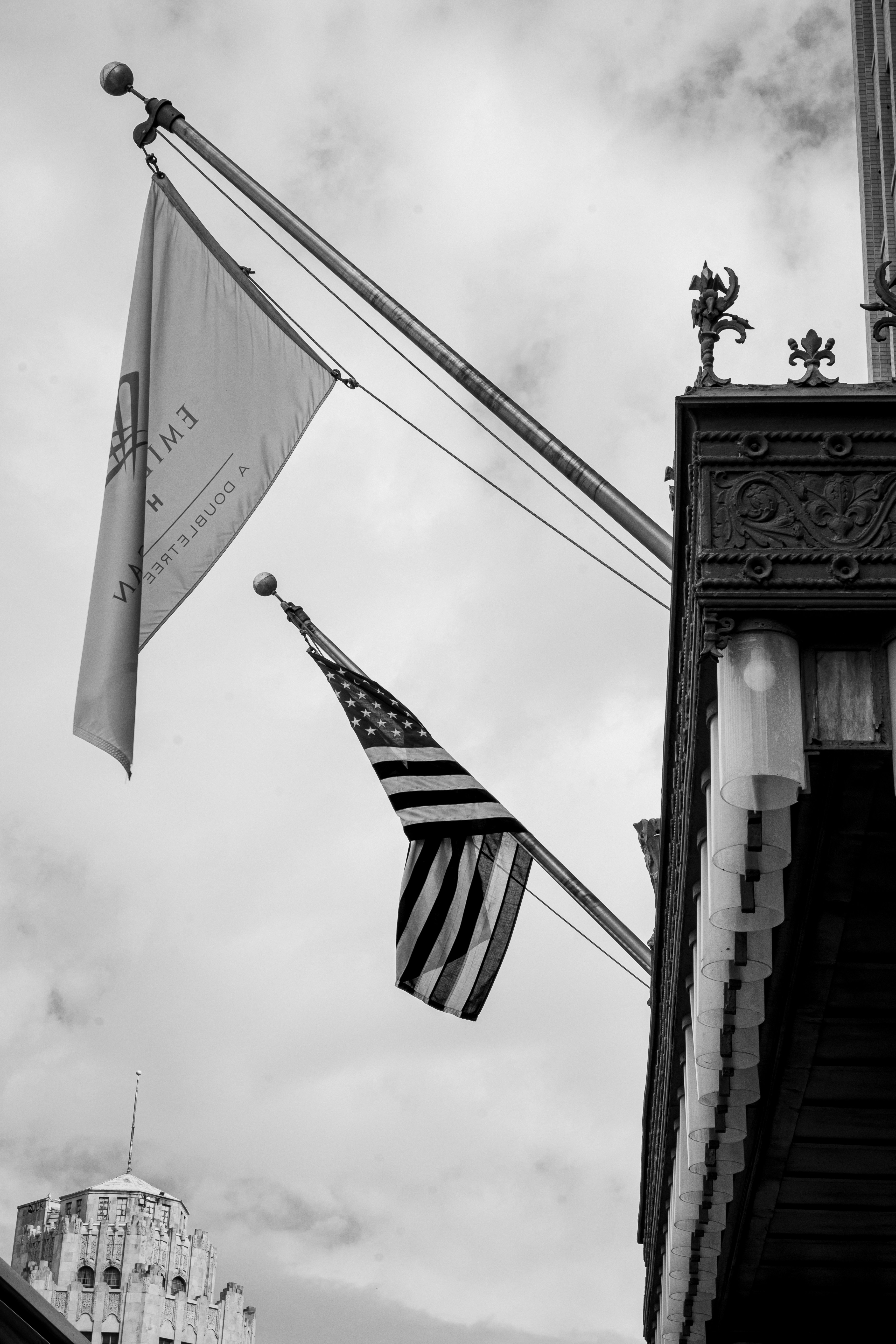 Flagpoles Against Ornate Architecture: A Monochrome Street Moment