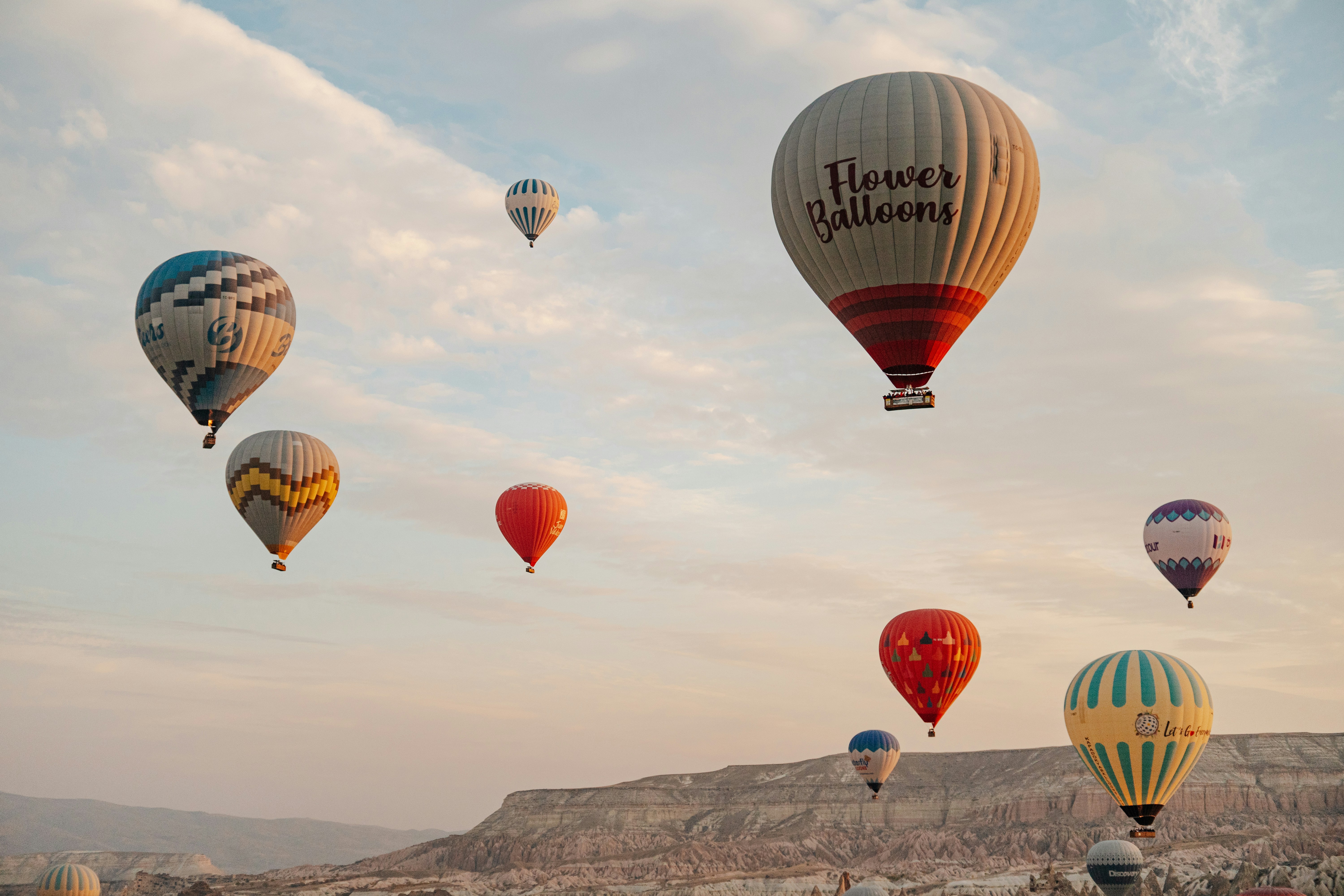 A bunch of hot air balloons flying in the sky photo – Free Göreme Image ...