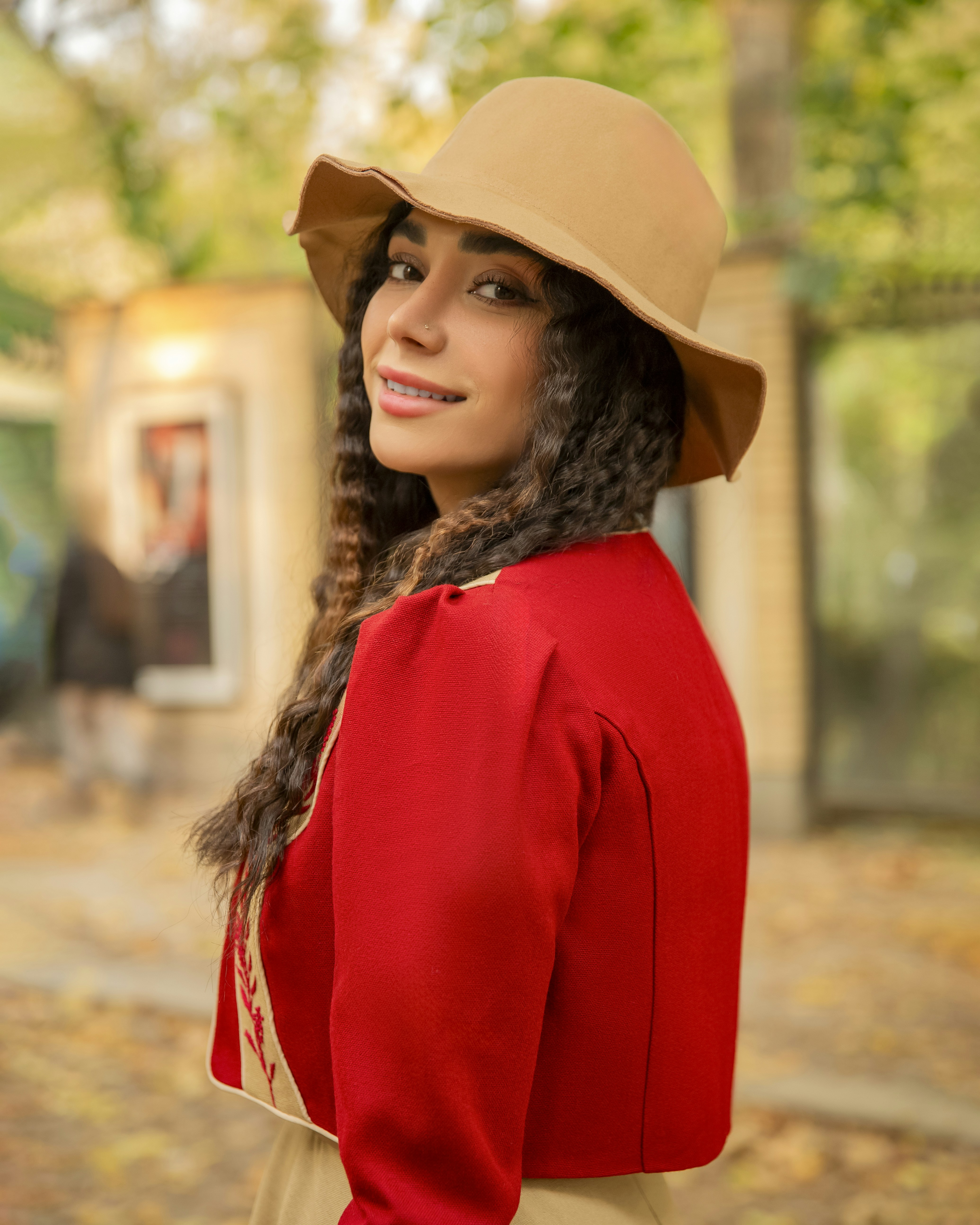 Crimson Coat in Dappled Light: A Sunny Park Portrait
