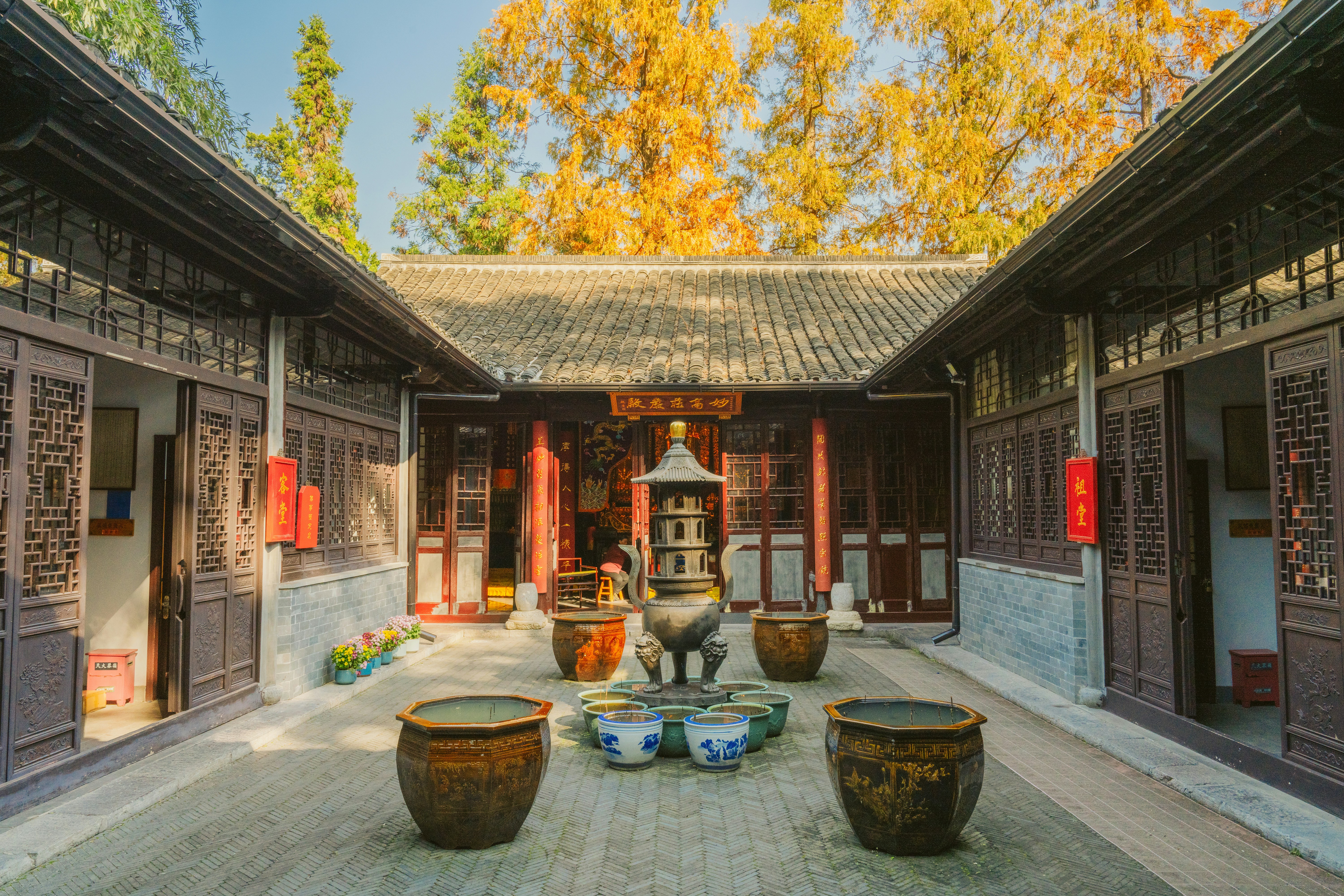 Symmetry at Dusk: The Incense Burner as Quiet Anchor in a Temple Courtyard