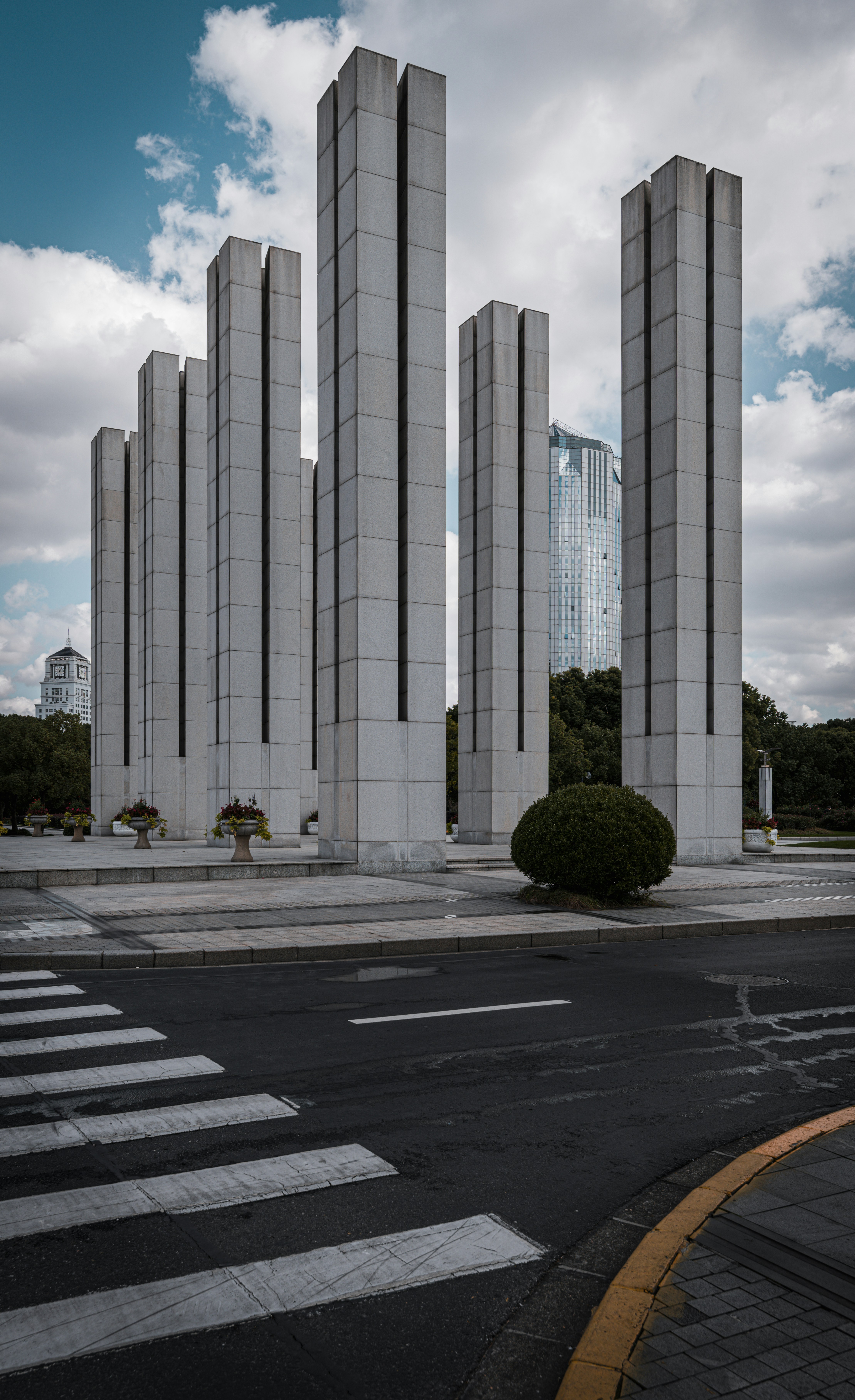 Concrete Sentinels: A Modern Plaza Framed by Skyscraper Columns