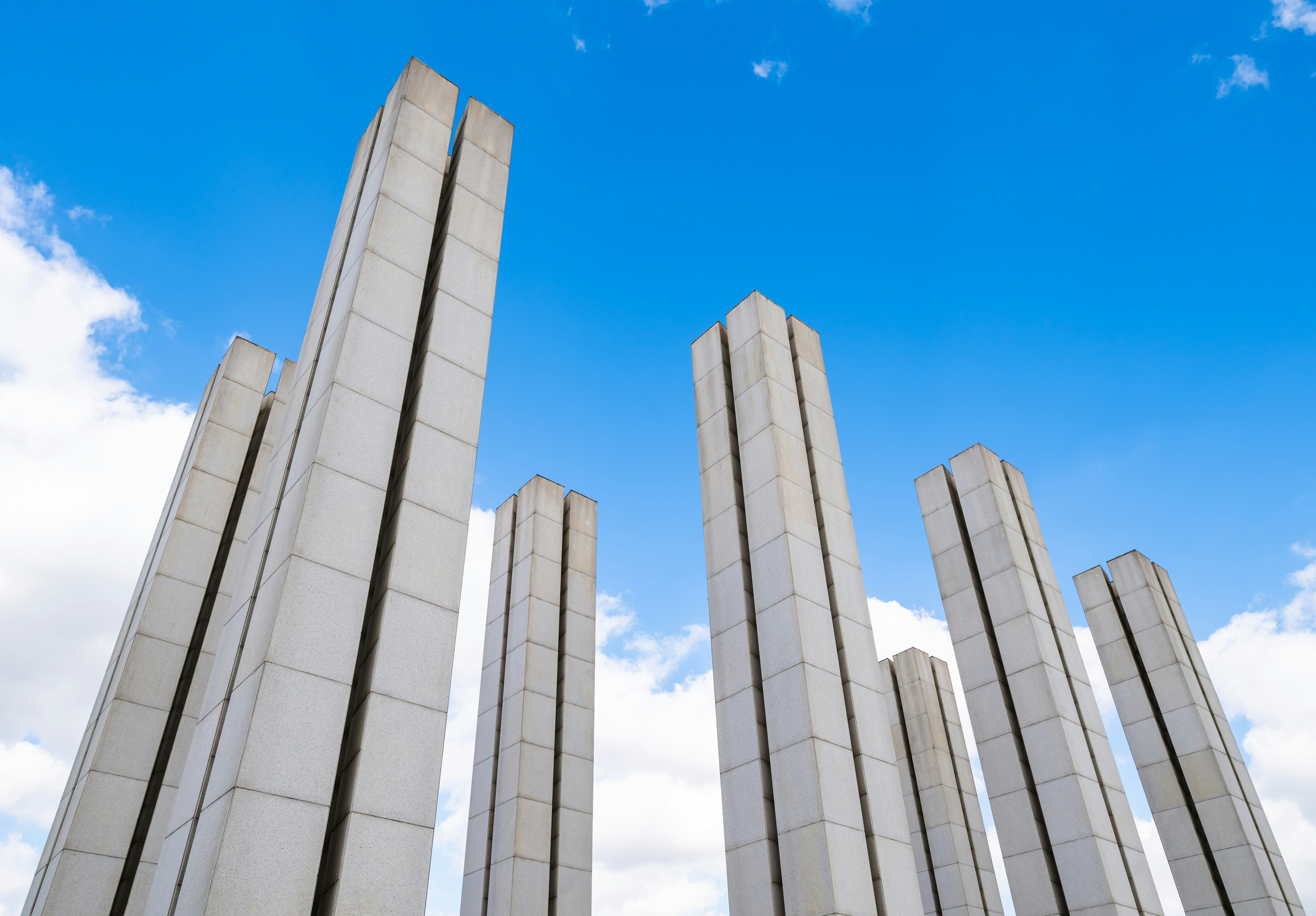 A group of tall concrete pillars sitting next to each other photo ...
