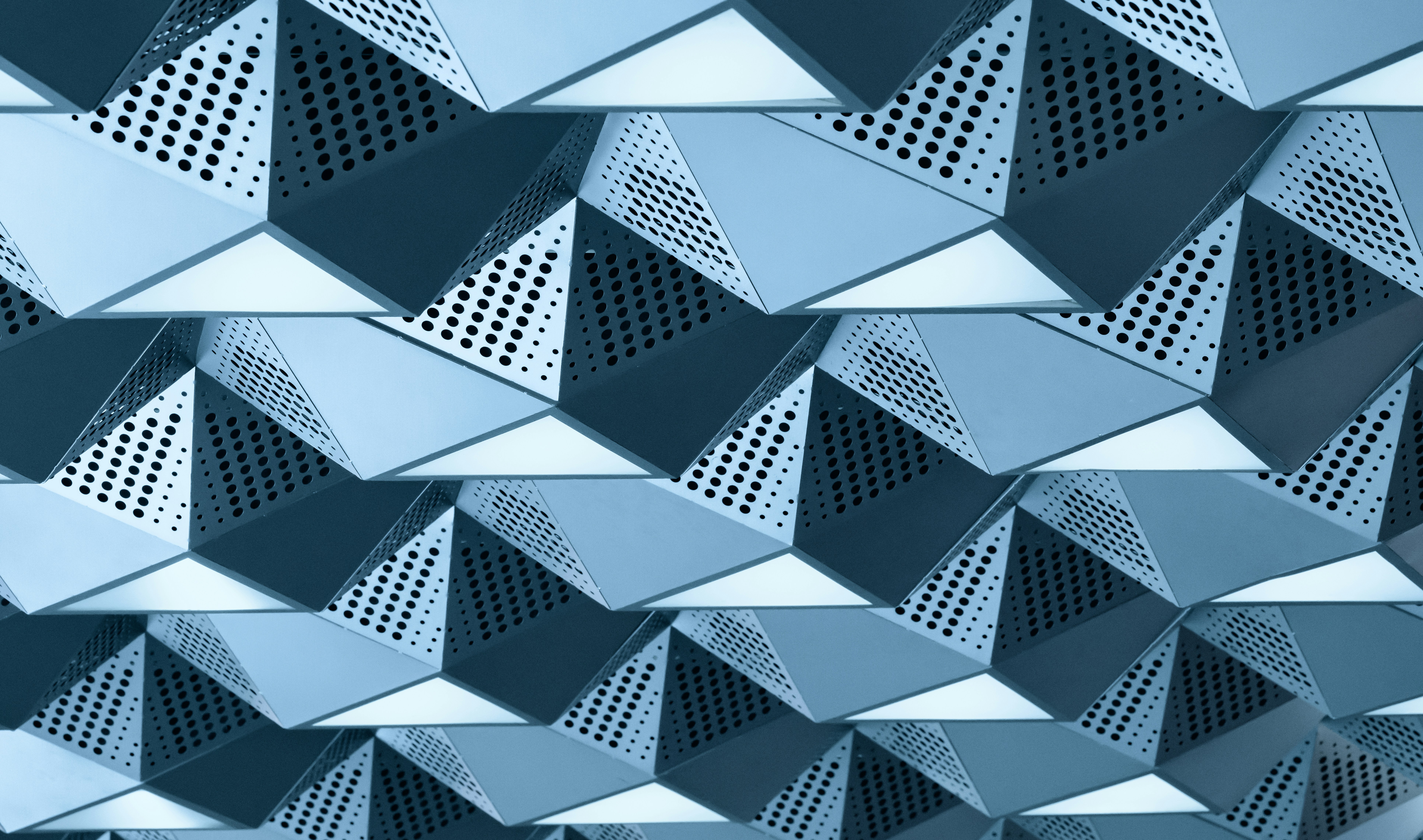 A metallic wall with a lot of triangles on it photo – Free Huangpu ...