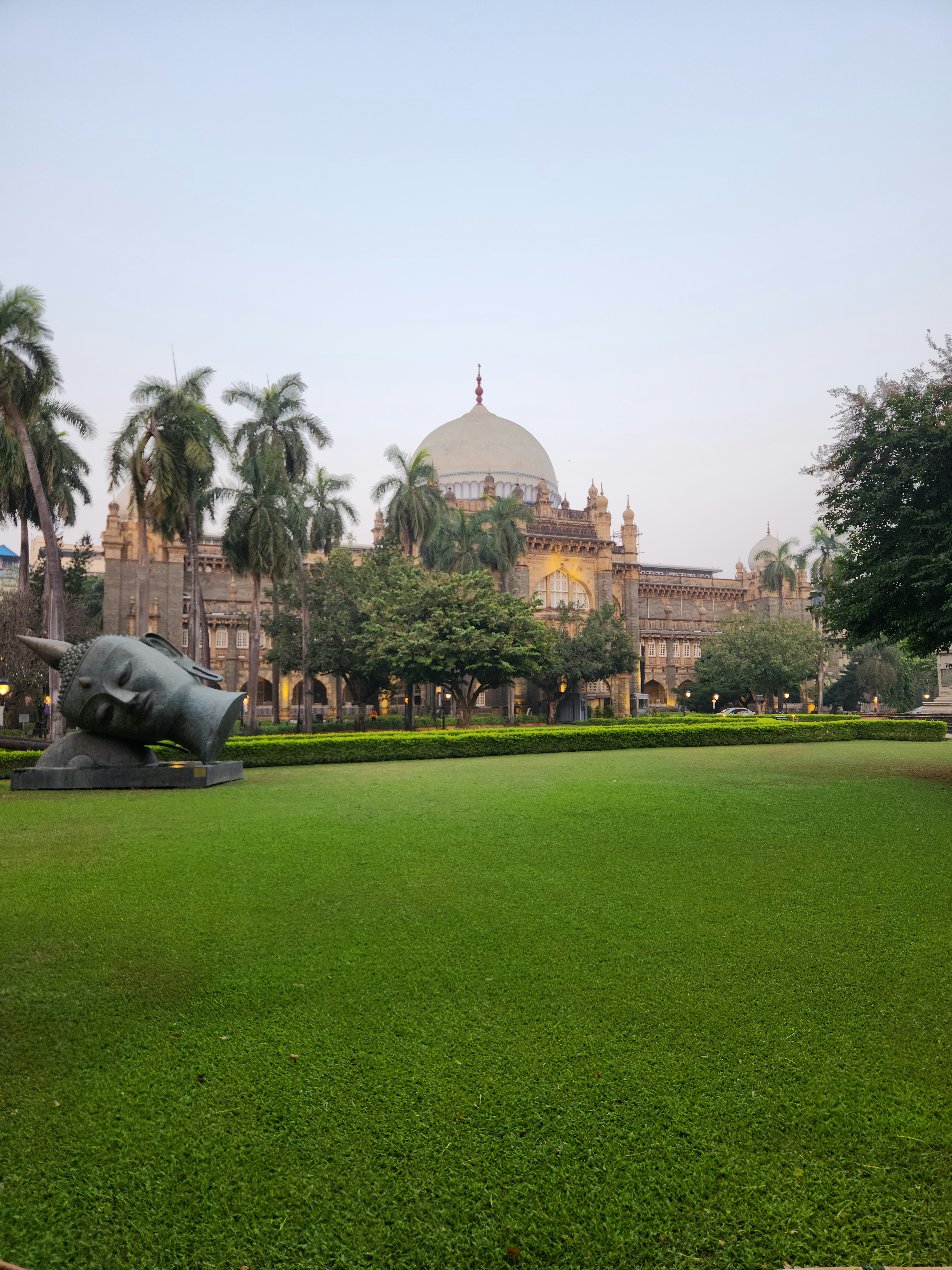 Leaning Head, Quiet Grandeur: A Park Scene Before a Dome