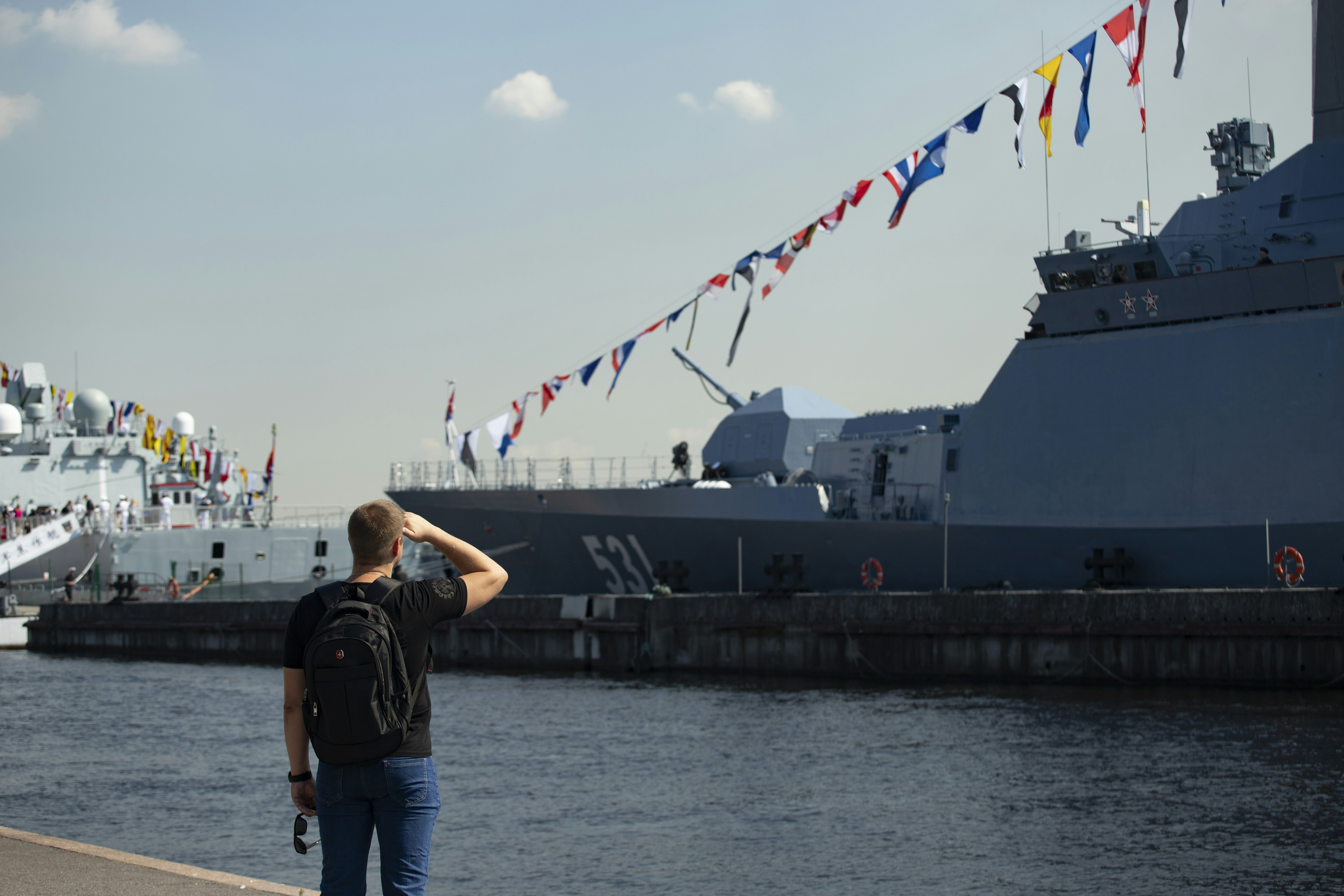 Man watching warships in Saint Petersburg Russia