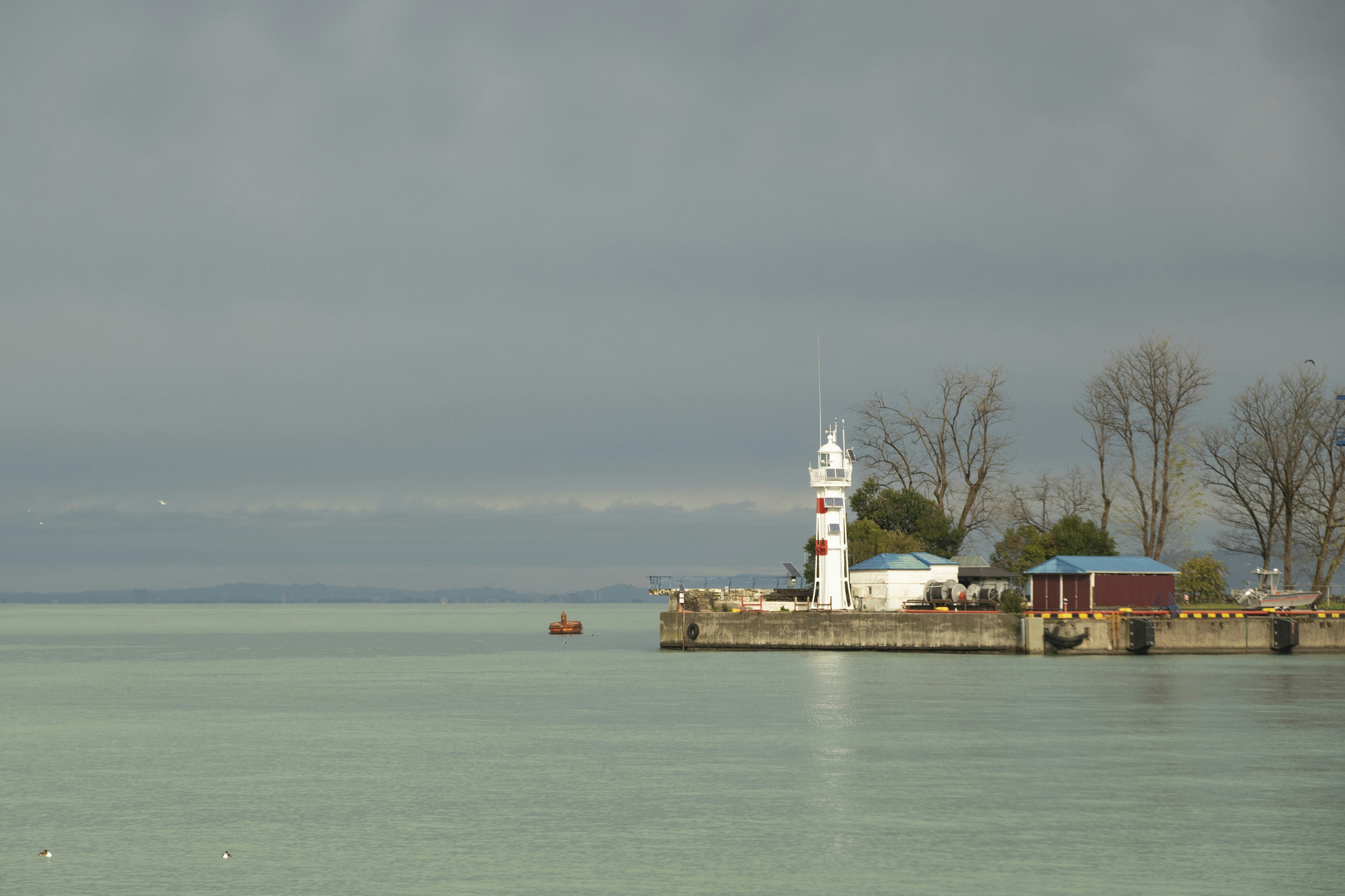 Lighthouse on a Misty Pier: Quiet Boundary Between Sea and Sky