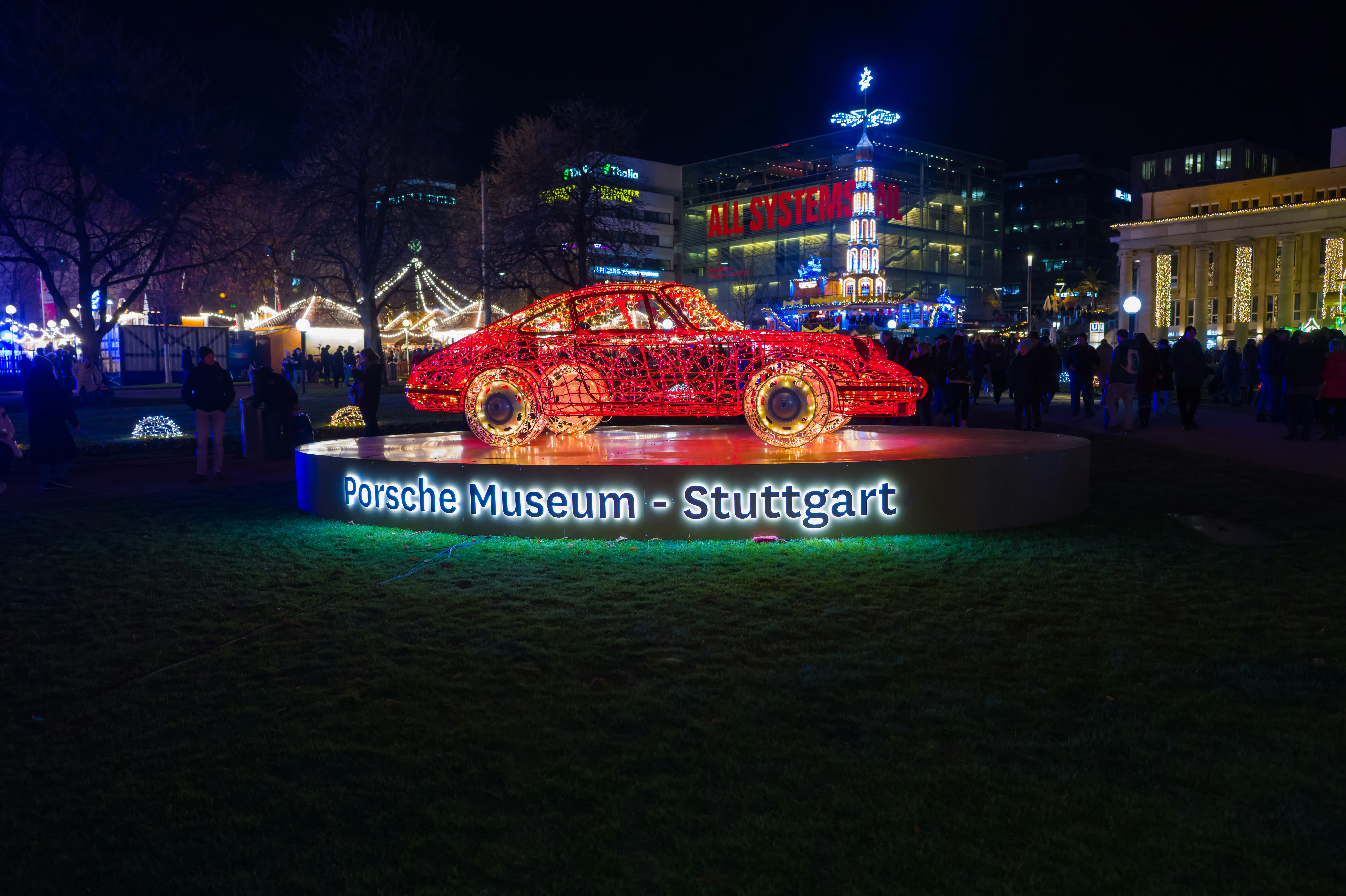 Luminous Red Car Sculpture Illuminates Stuttgart's Porsche Museum Nightscape