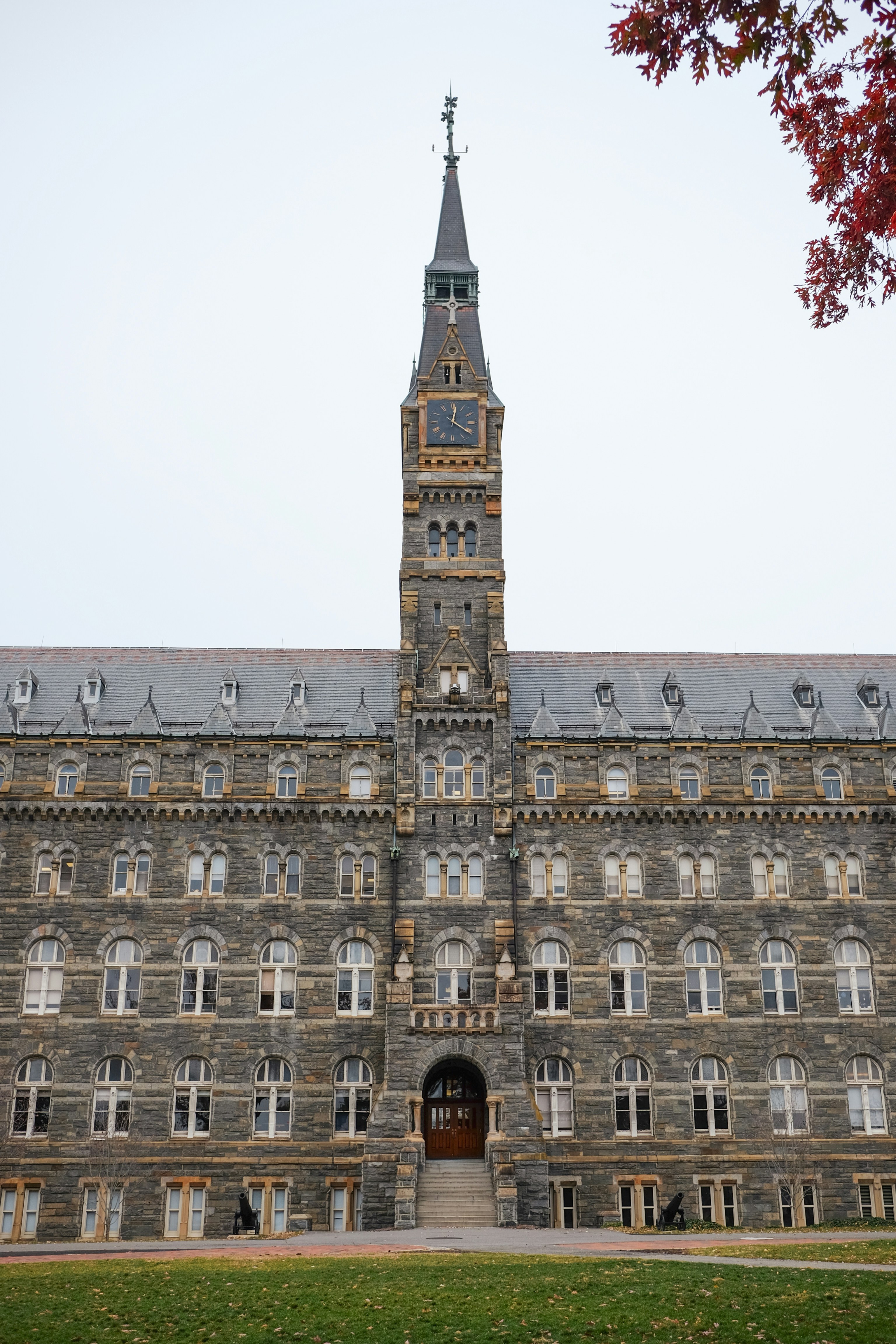 A large building with a clock tower on top of it photo – Free ...