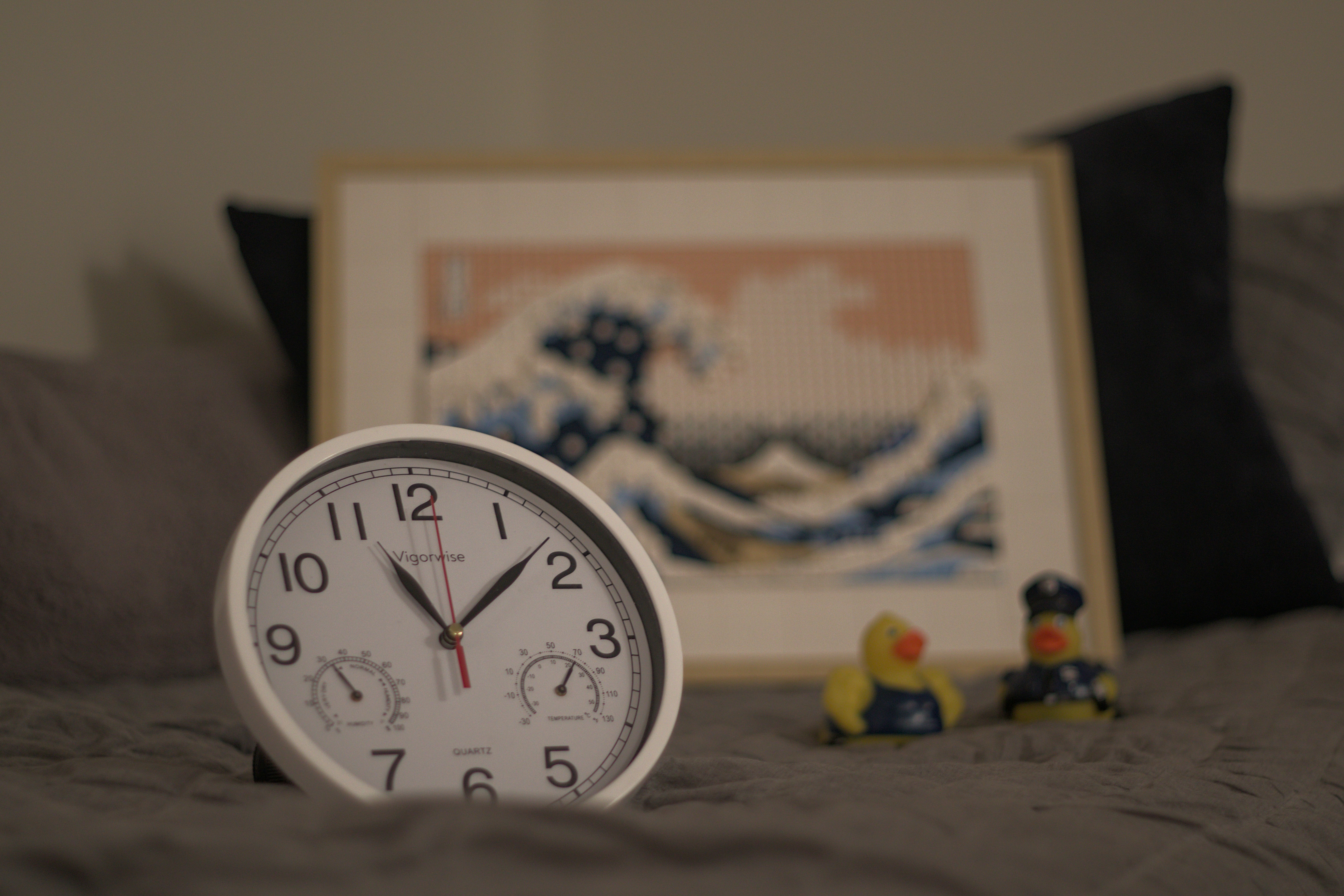 Beside the Bedside Clock: Tiny Figures and a Wave of Framed Calm