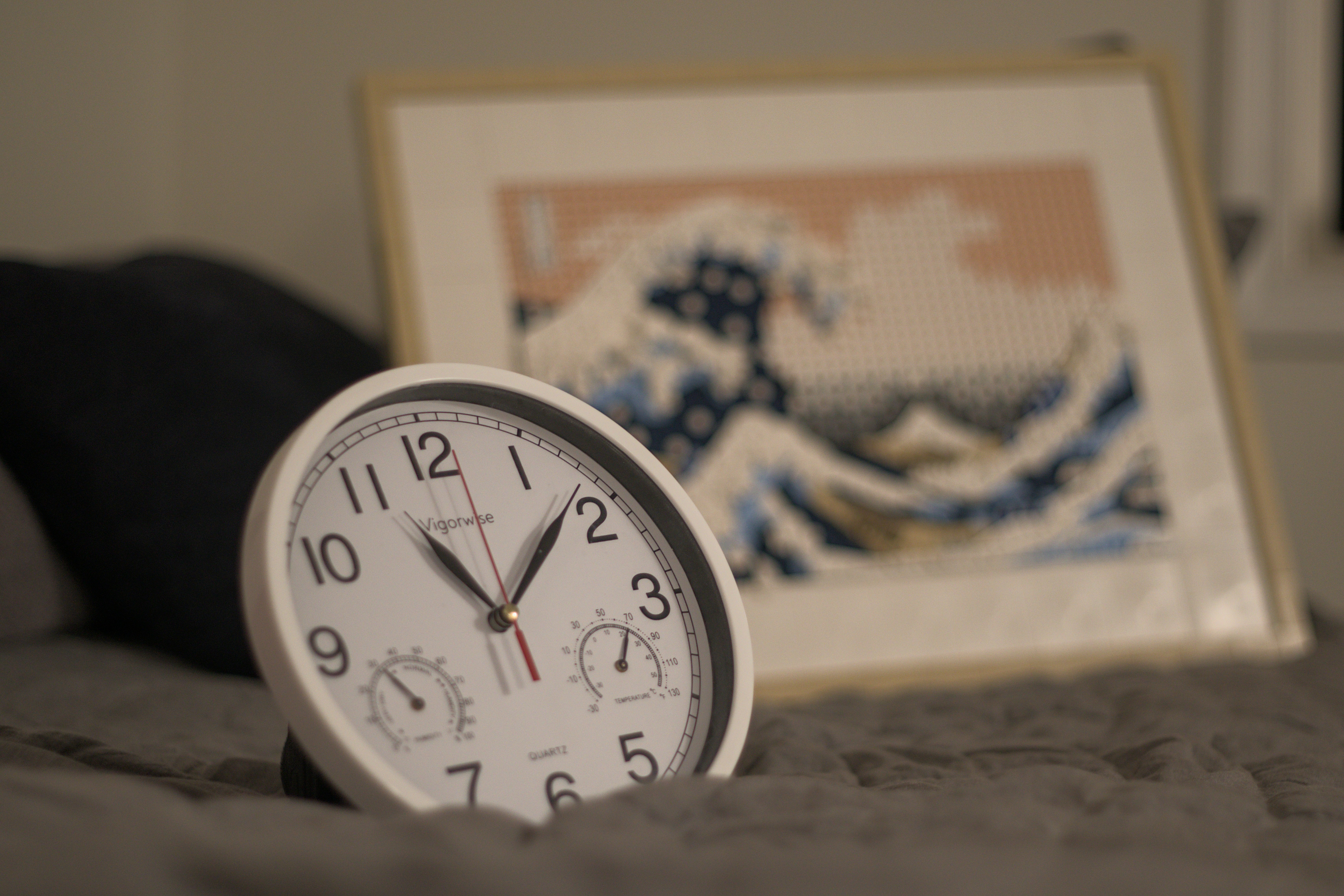 Time on a Soft Stage: A Clock in Focus Before a Blur of Ocean Art