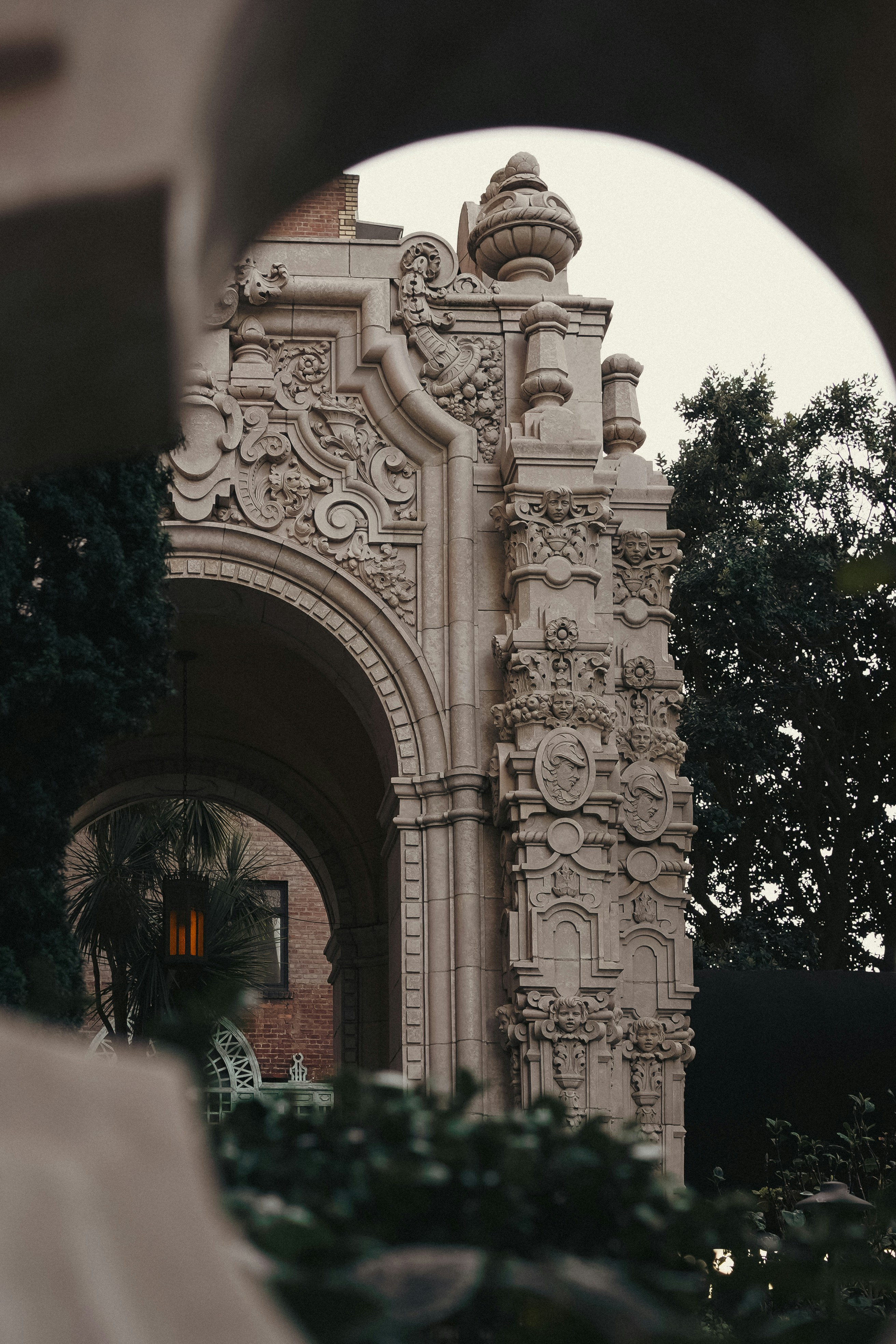 Carved Portal: The Ornate Archway Dominating a Quiet Courtyard