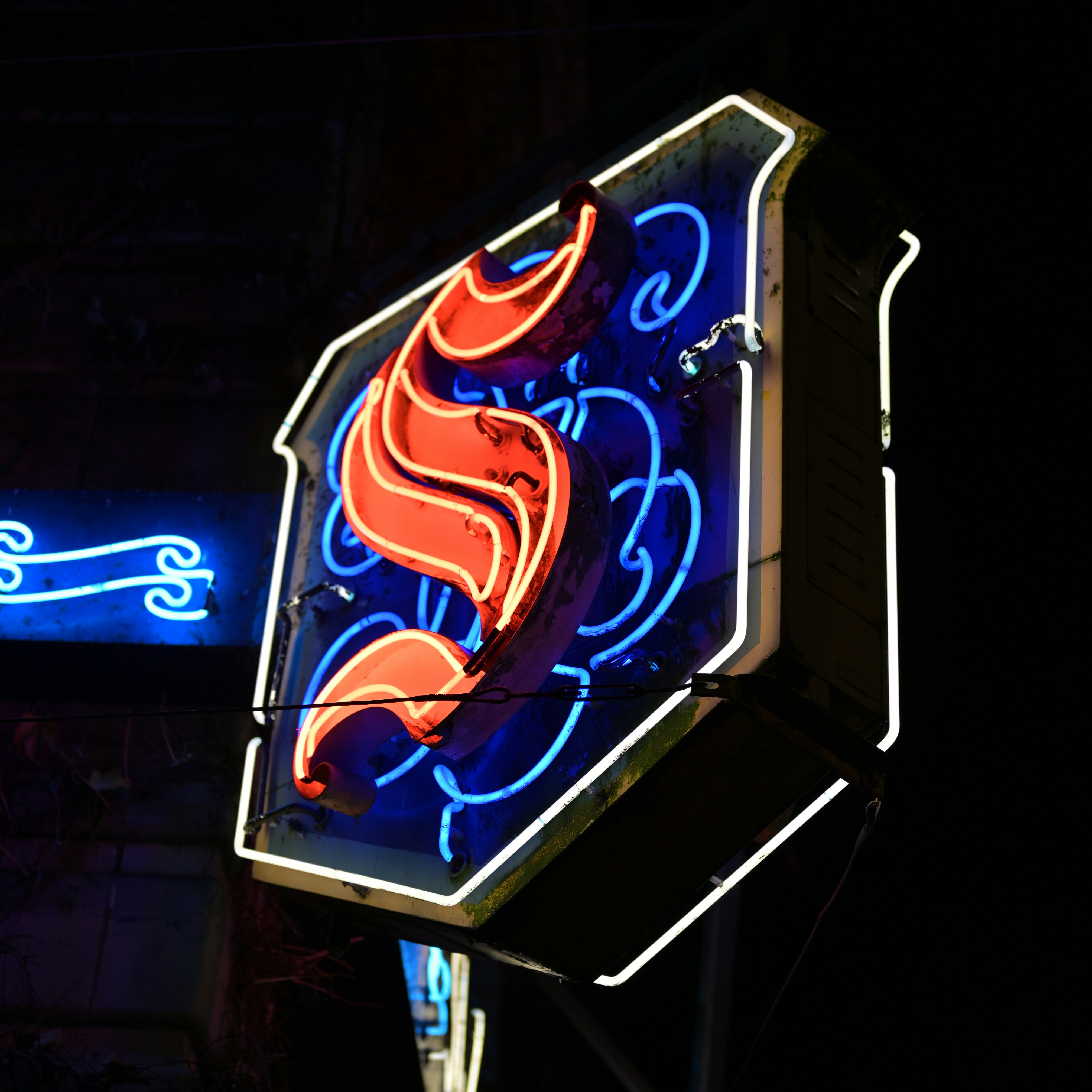Neon Hex: A Red Emblem Illuminates the Night