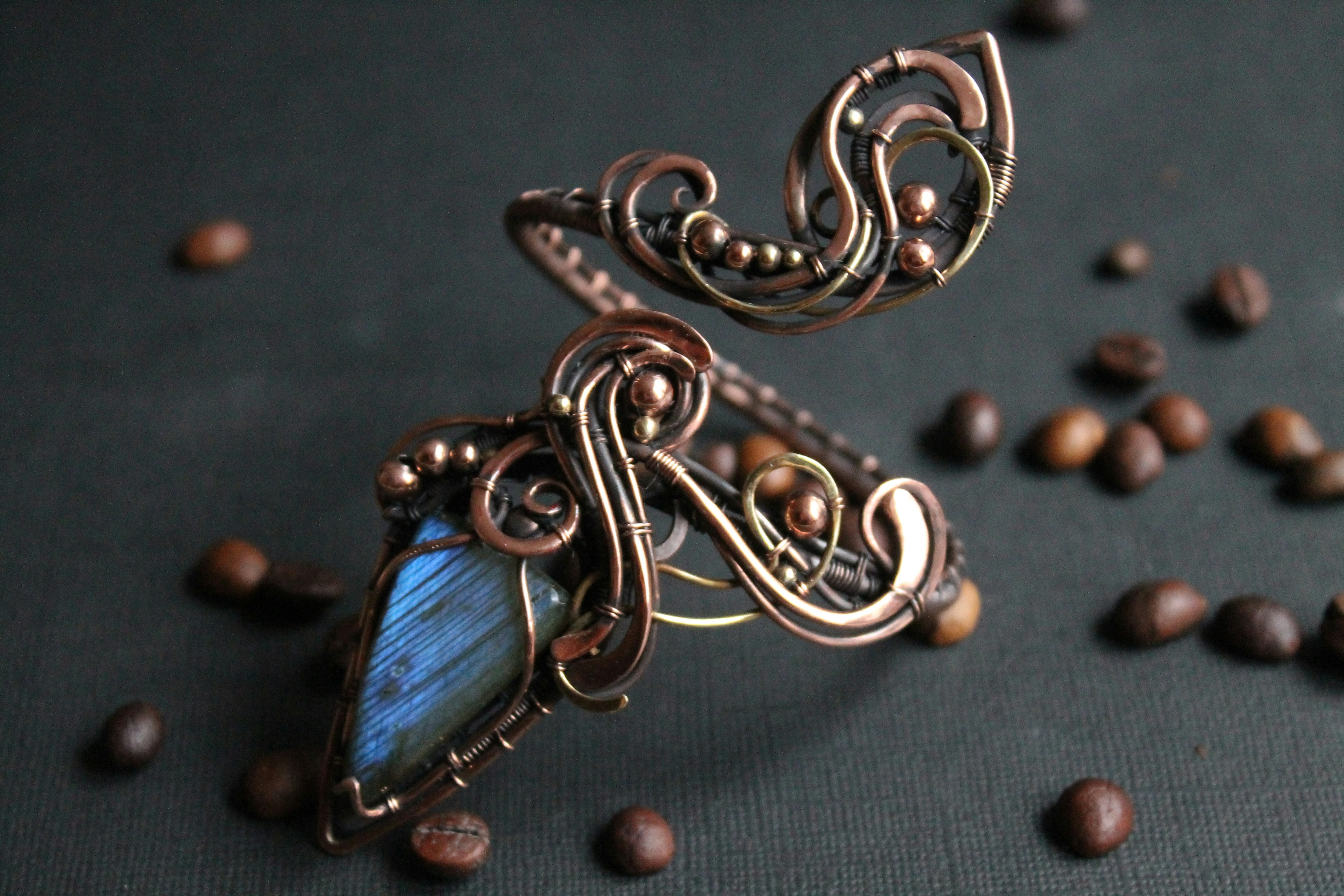 Copper-wire Gem Pendant Nestled Among Coffee Beans