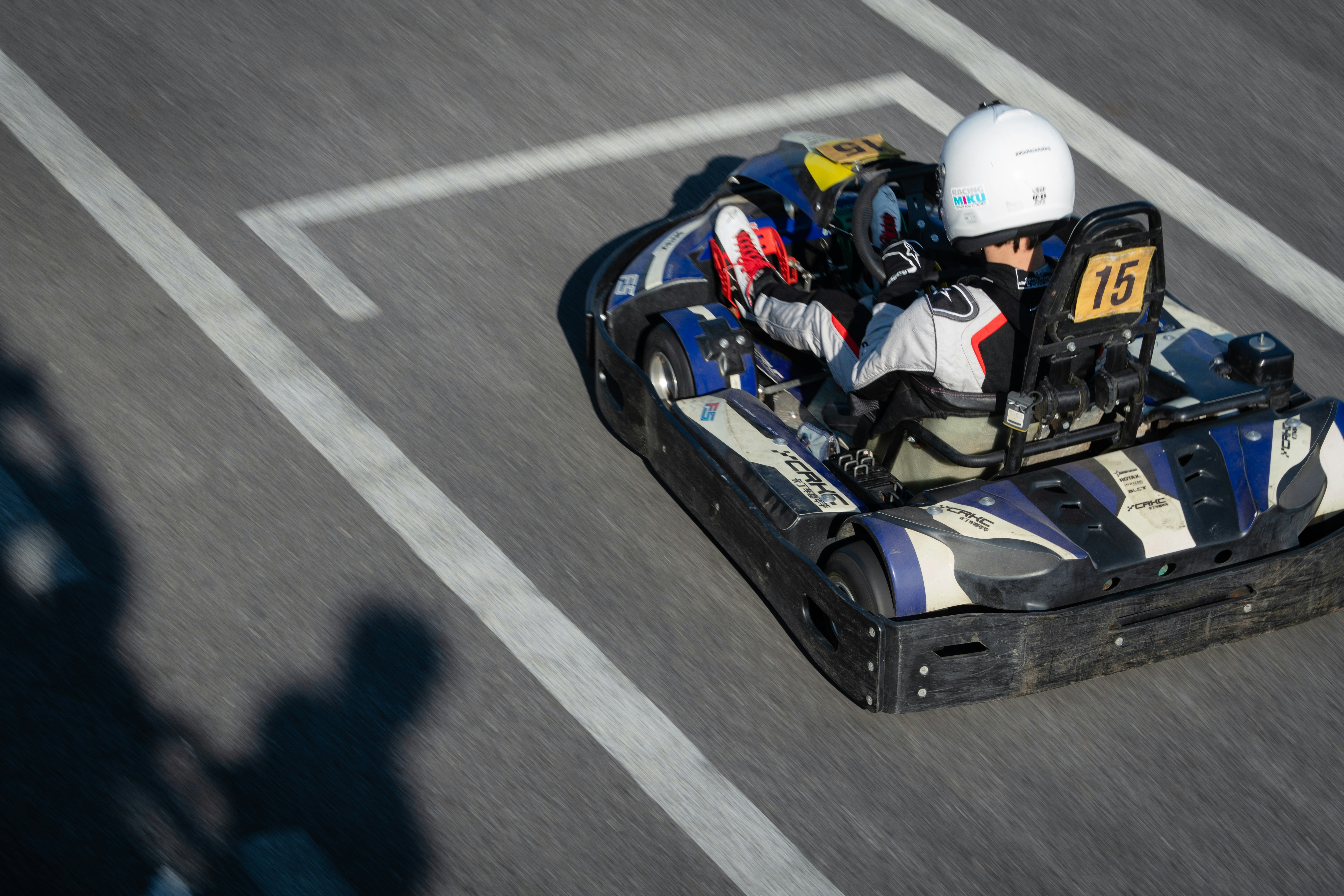 A person in a go kart driving down a street photo – Free Car Image on ...