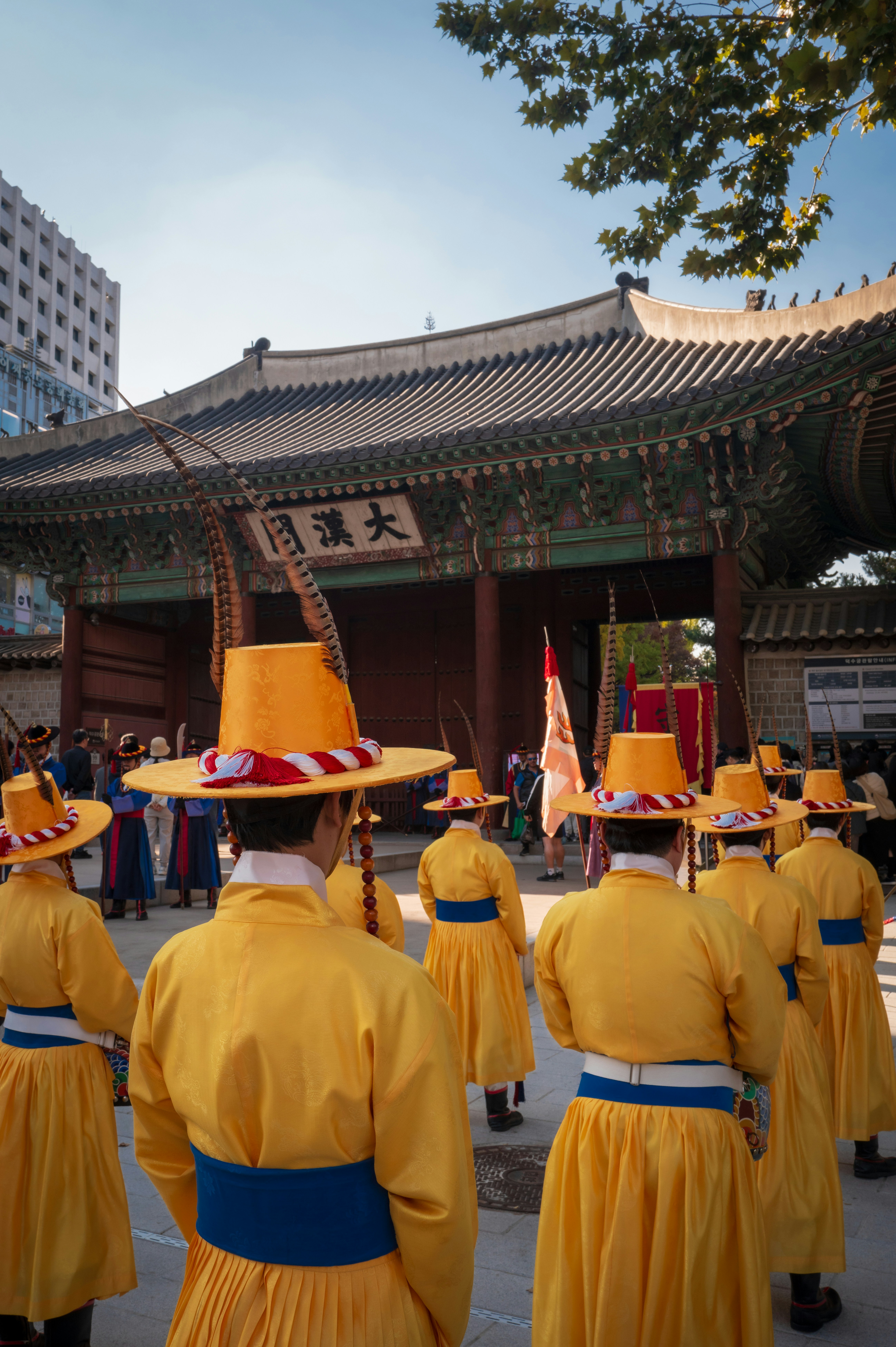 A group of people in yellow dresses and hats photo – Free People Image ...