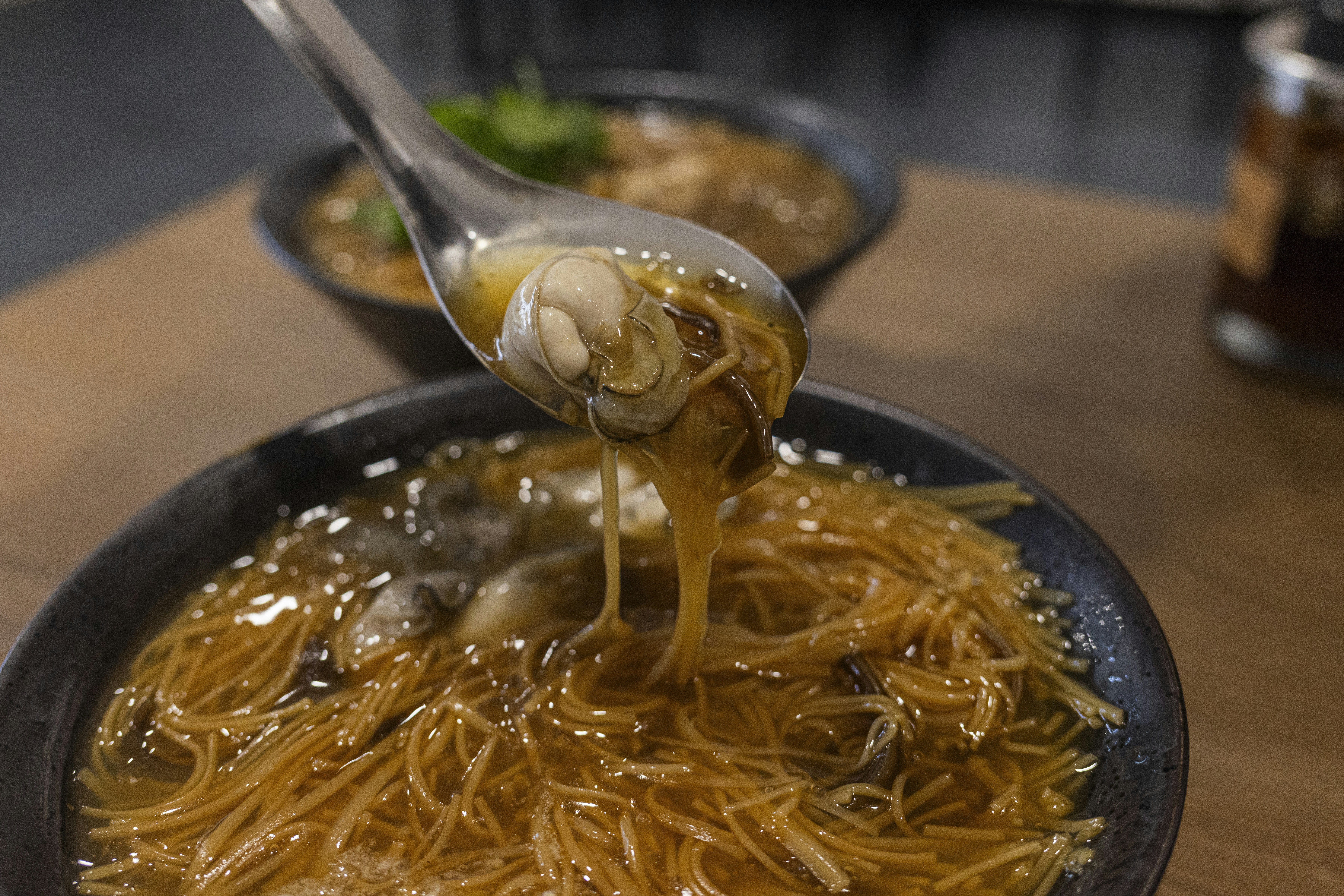 A spoon full of noodles being lifted from a bowl photo – Free Food ...