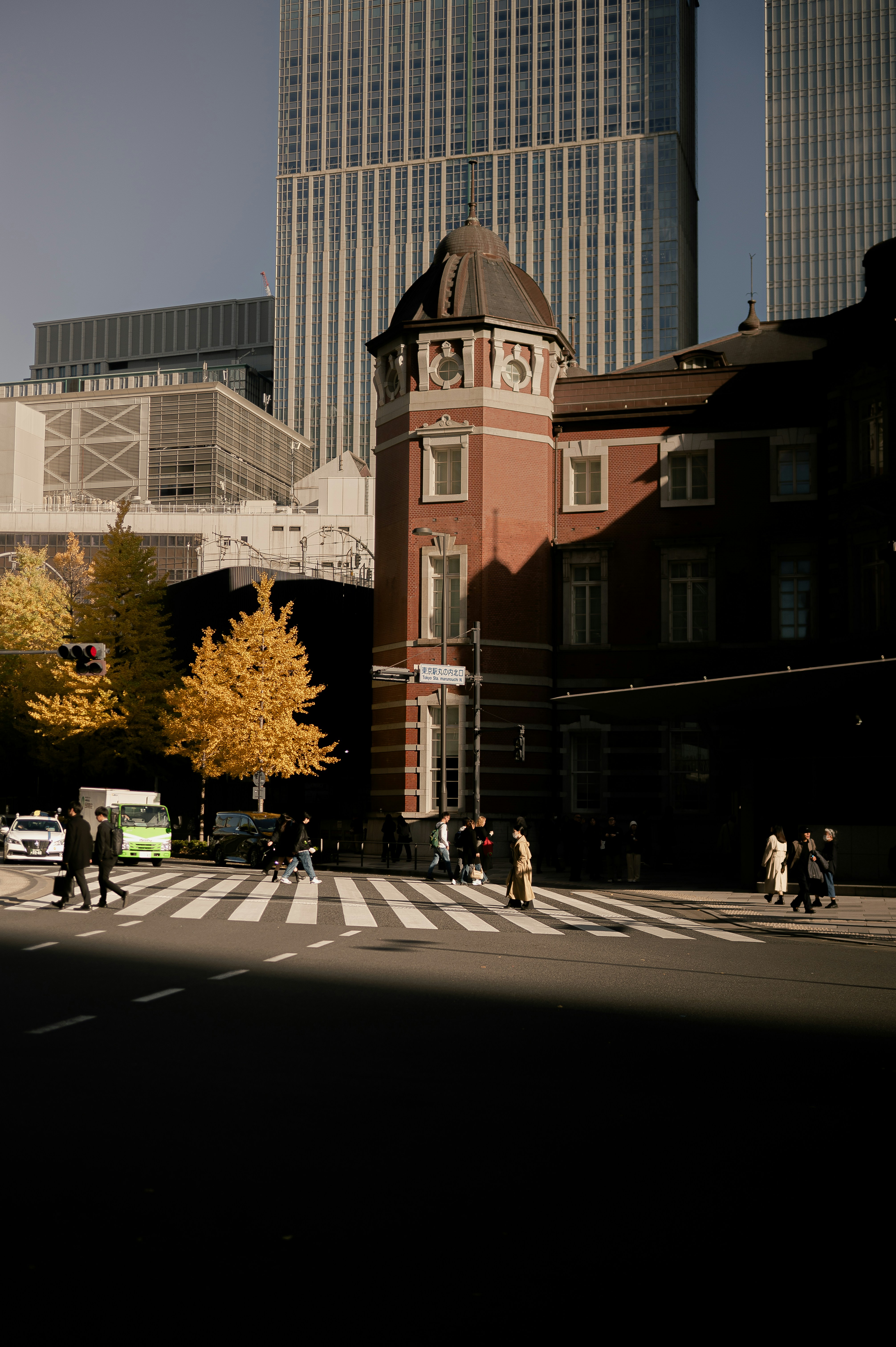 Autumn Crossing: The Brick Turret Among Glass Giants