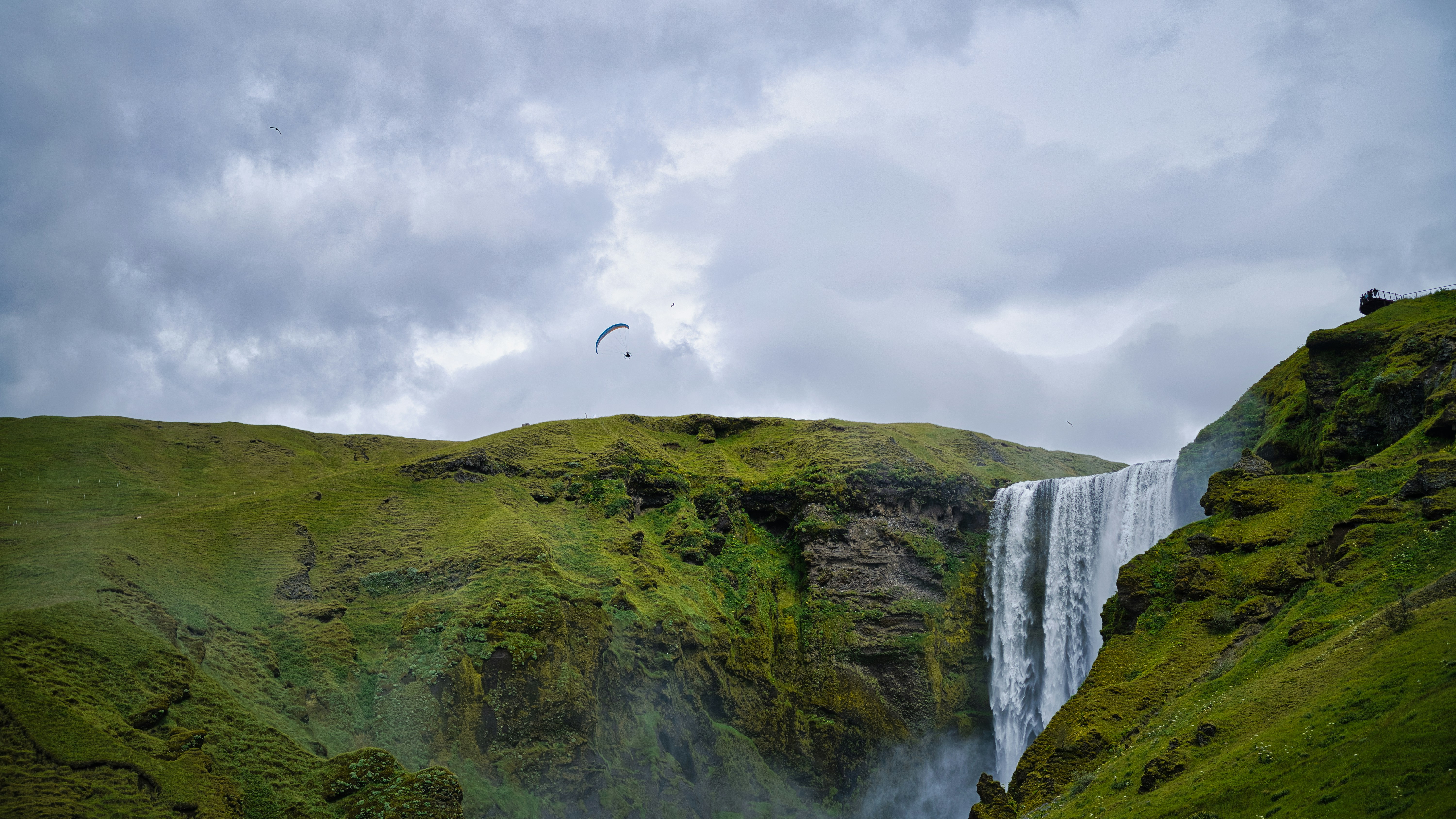 A waterfall with a bird flying over it photo – Free Skógafoss Image on ...