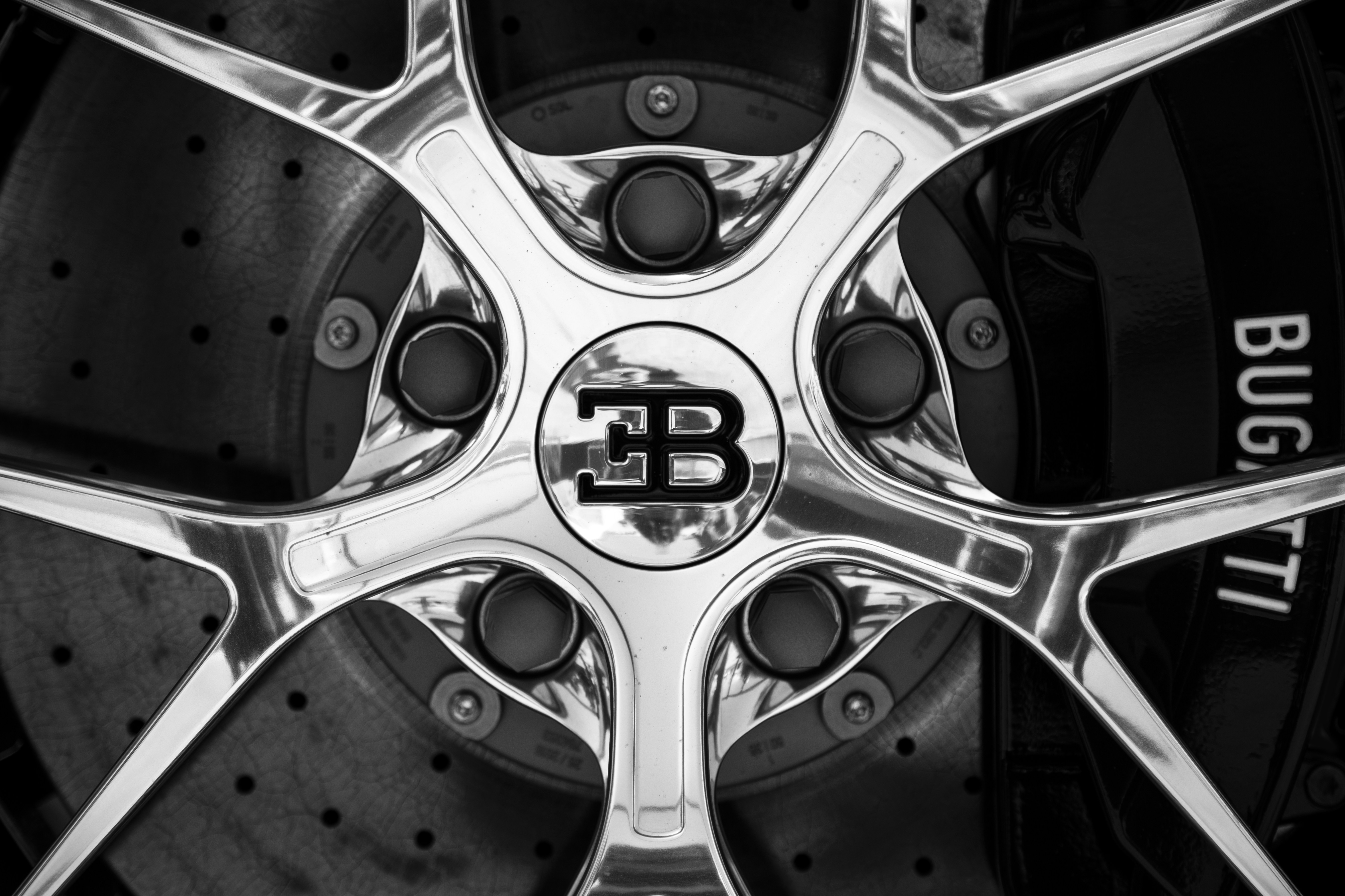 Chrome starburst behind a Bugatti wheel hub